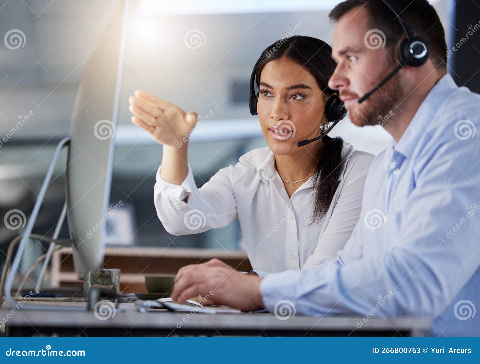 Ill Direct You. Two Call Centre Agents Working Together on a Computer ...