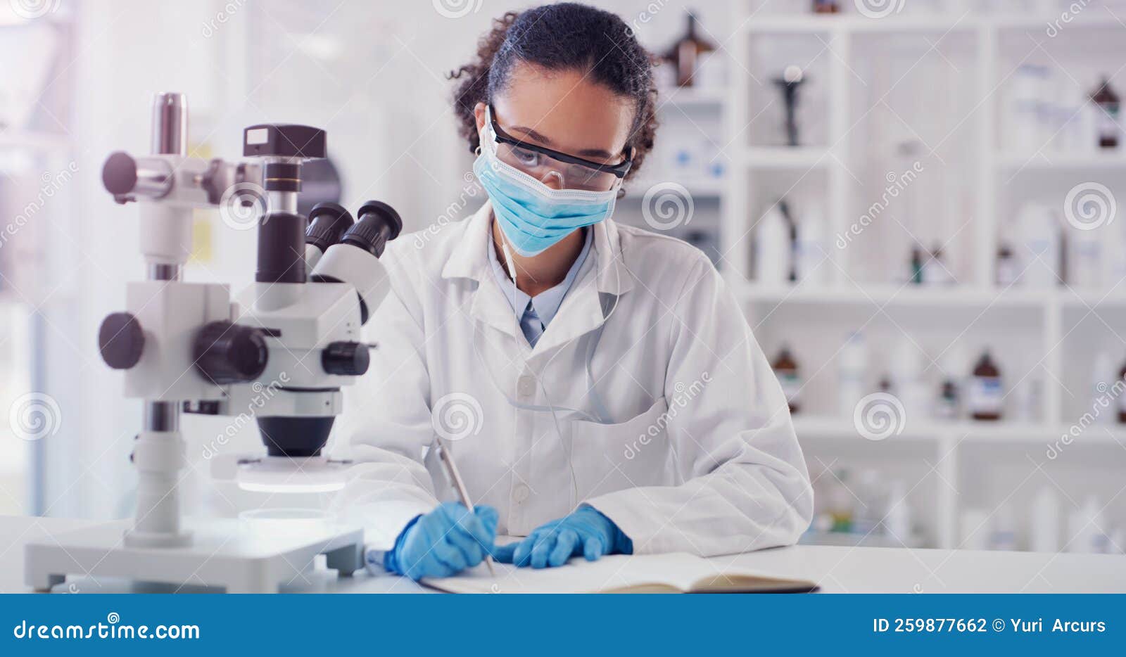 Ill Make a Note of that. a Young Scientist Writing Notes while Using a ...