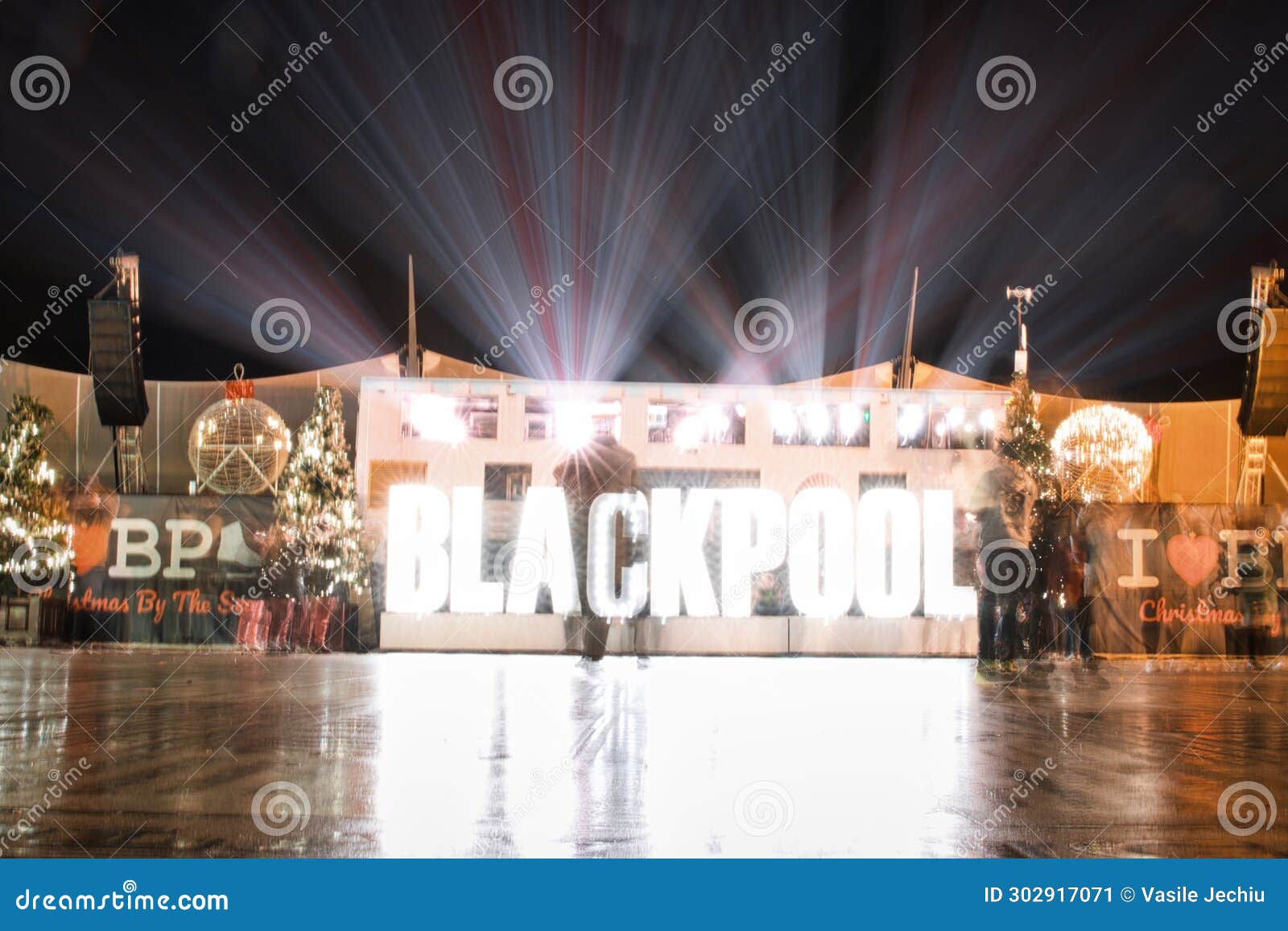 Illuminated Blackpool Sign with Light Rays at Night, Reflecting on Wet ...