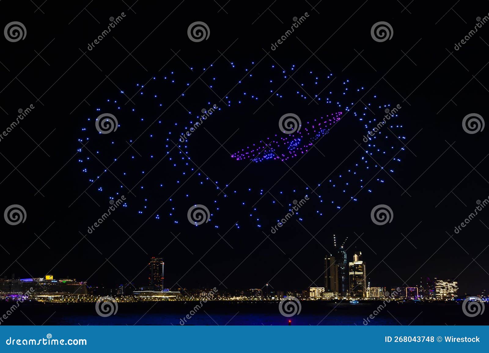 Illuminated Blue Drones Glowing in the Black Night Sky and Forming ...