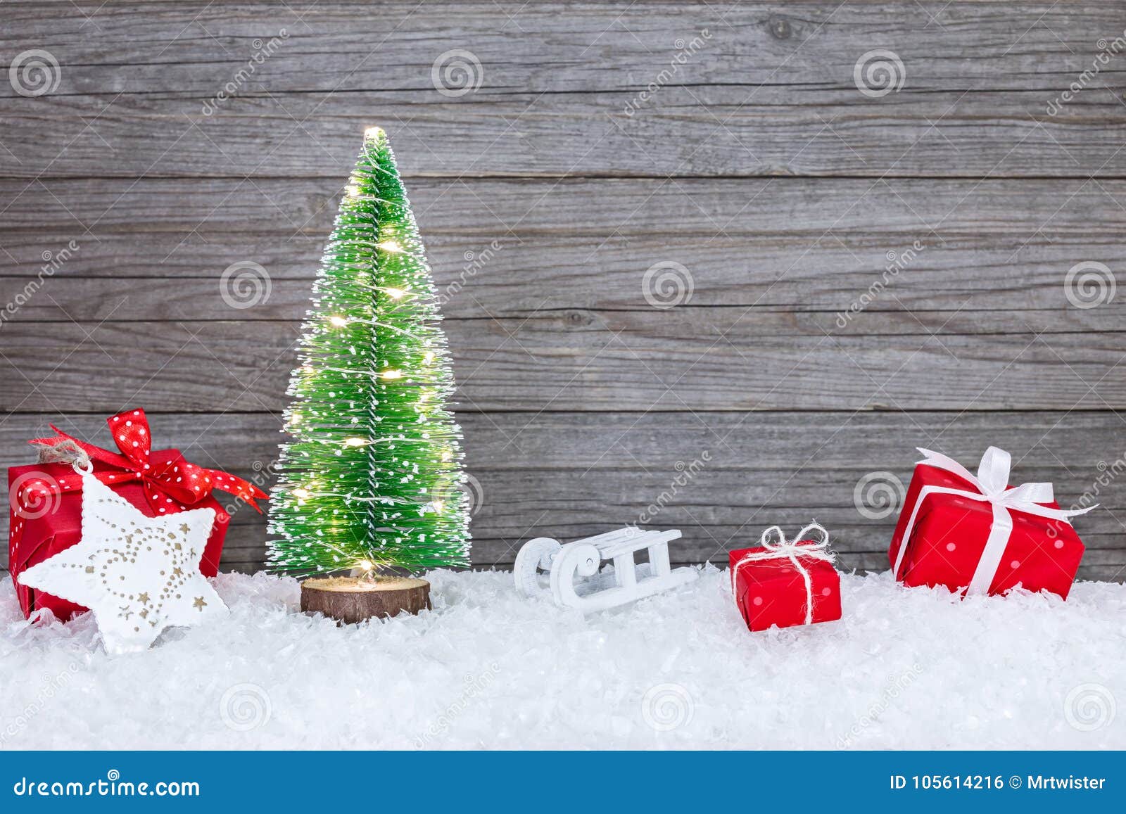 Illuminated Christmas Tree with Red Gift Boxes, Sledge and Star Stock ...
