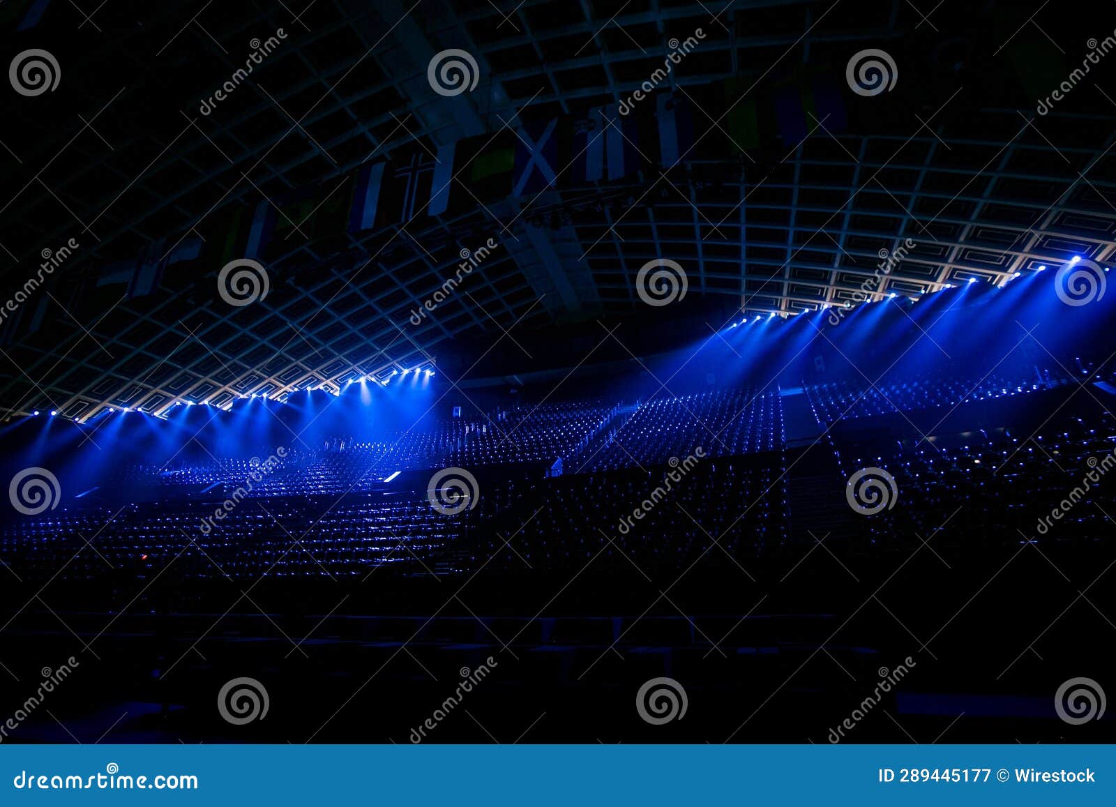 Illuminated Empty Blue Stadium with a Large Stage Stock Image - Image ...