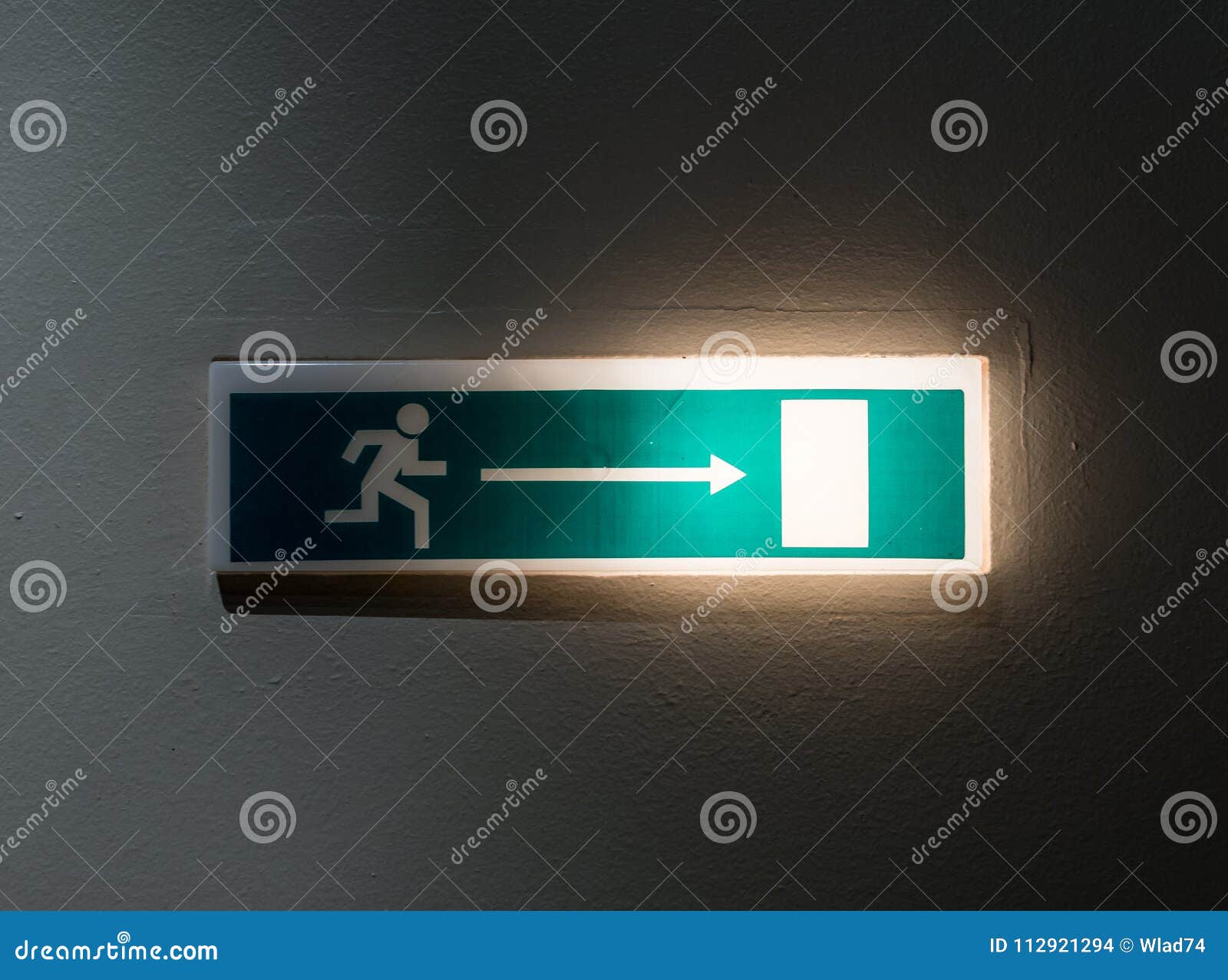 The Illuminated Green Exit Sign in Dark Room Stock Photo - Image of ...