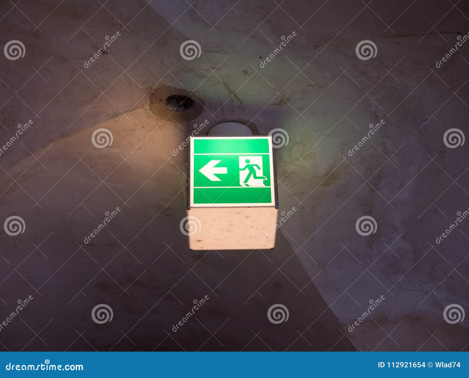 The Illuminated Green Exit Sign in Dark Room Stock Photo - Image of ...