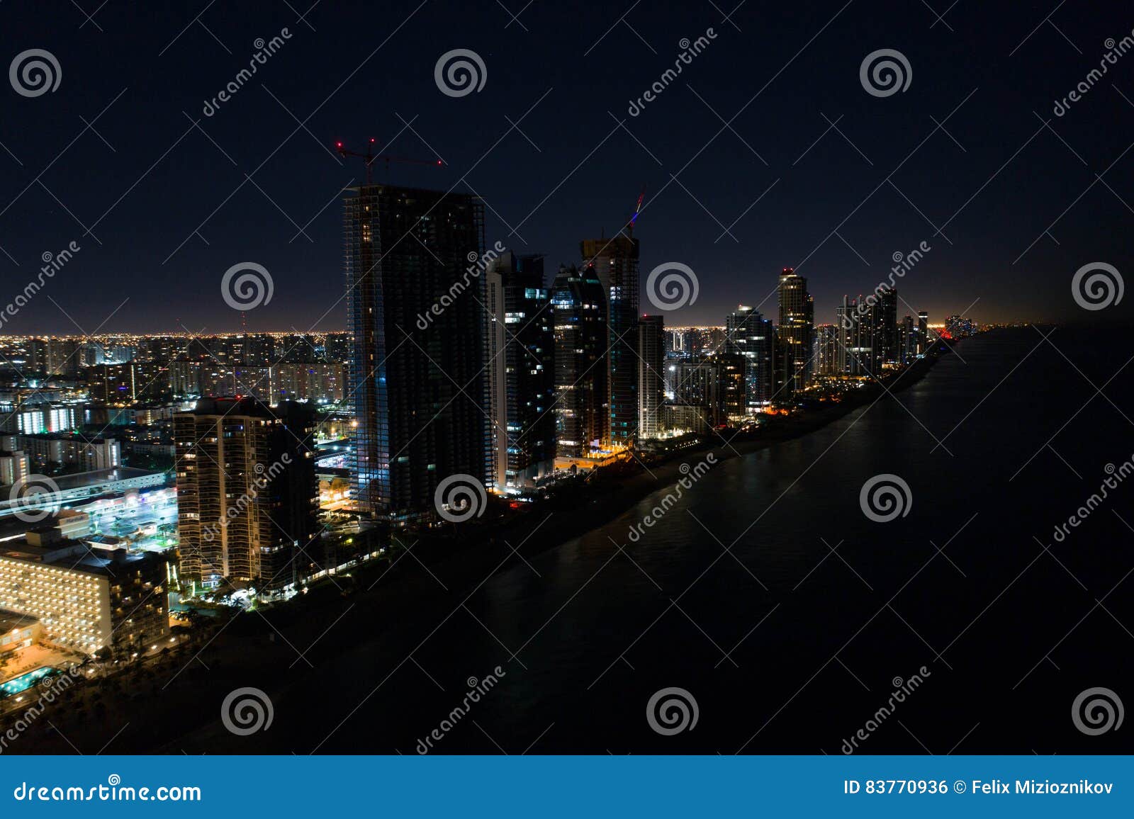 Illuminated Highrise Structures on the Beach at Night Stock Photo ...