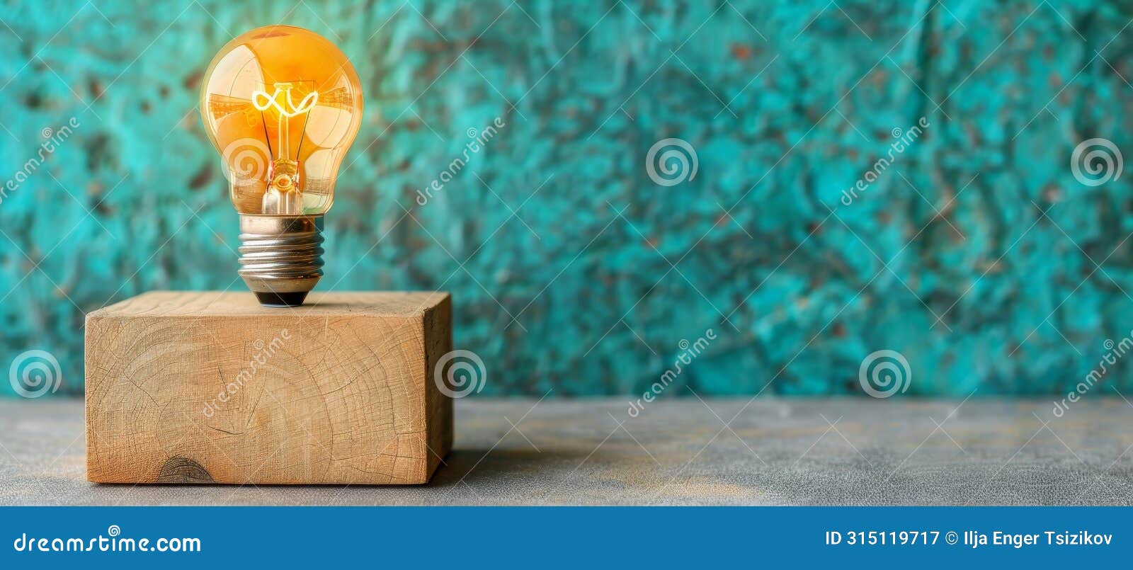 Illuminated Light Bulb On Block With Space For Text On Plain Background ...