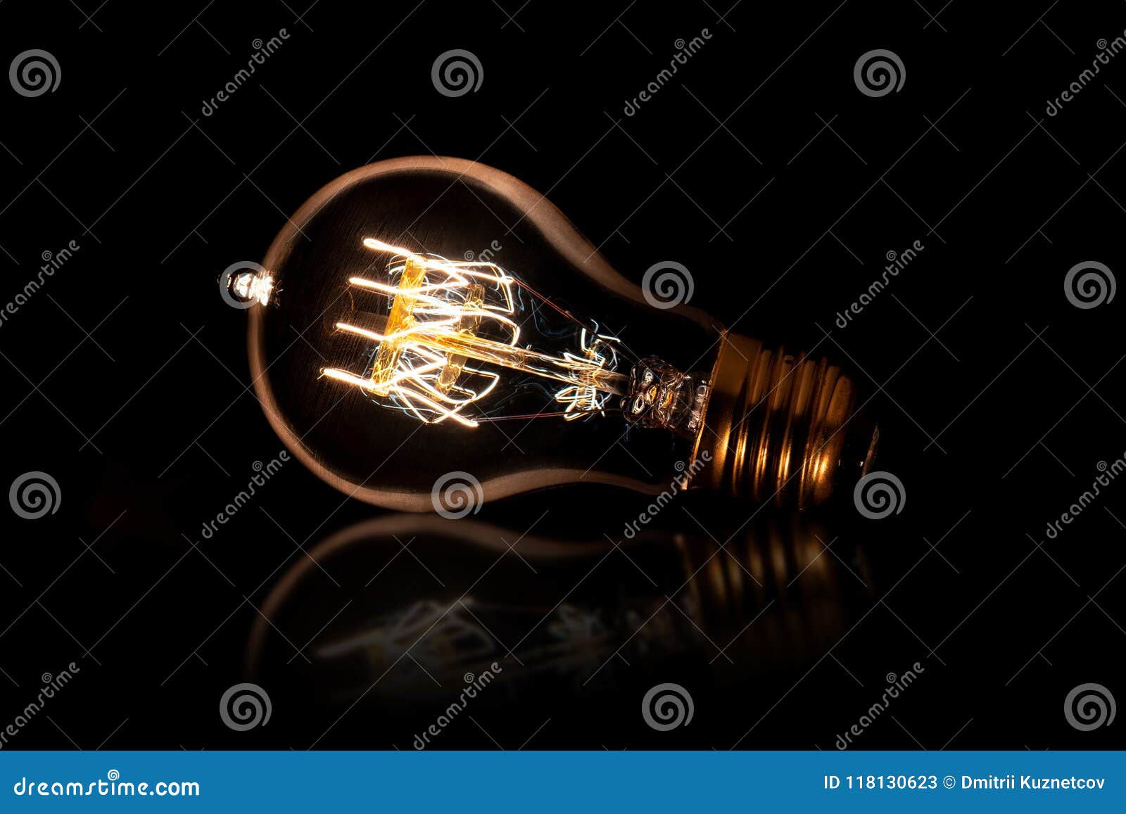 Illuminated Light Bulb with Reflection Lying Stock Image - Image of ...