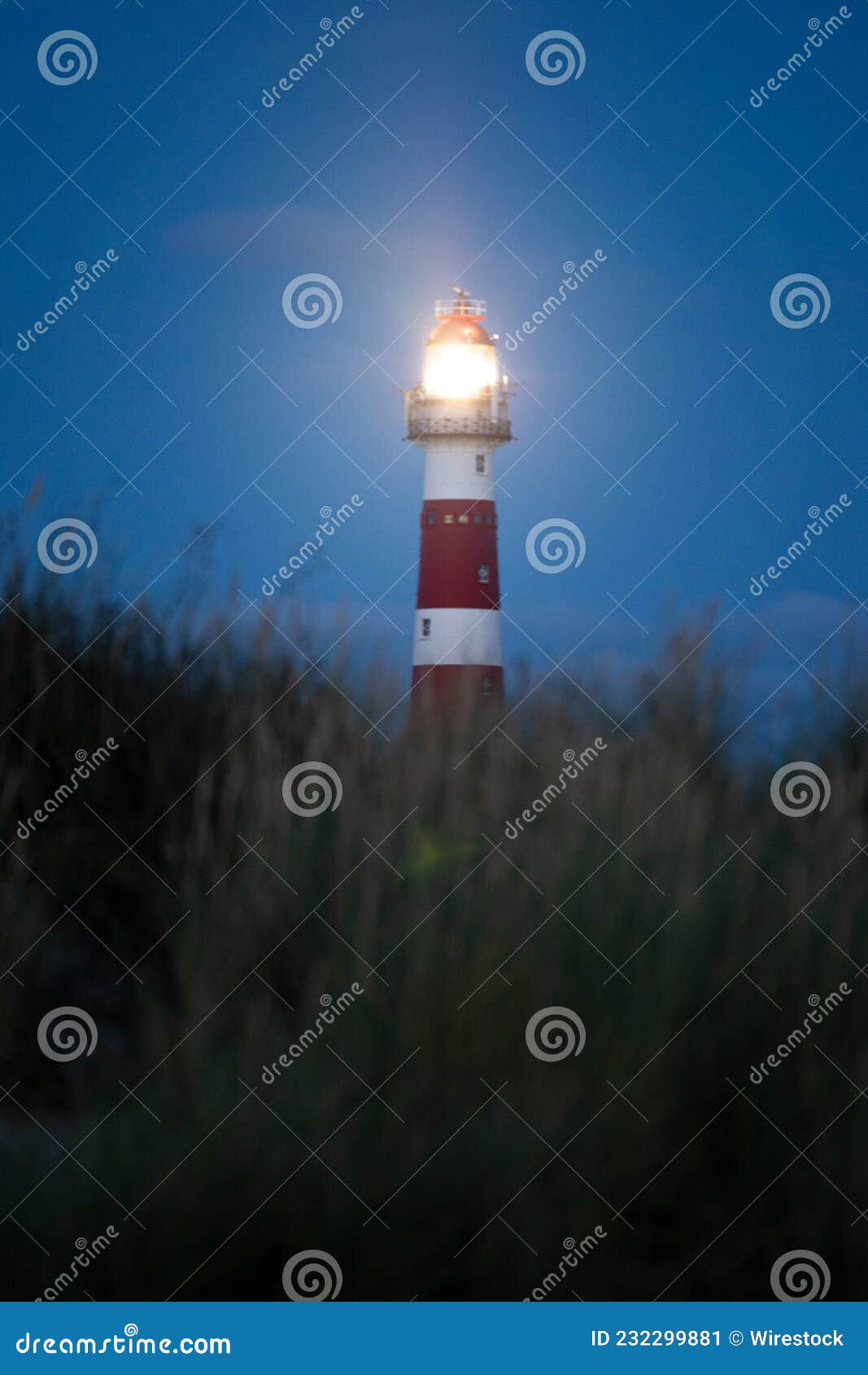 Illuminated Lighthouse in the Evening Stock Image - Image of blue ...