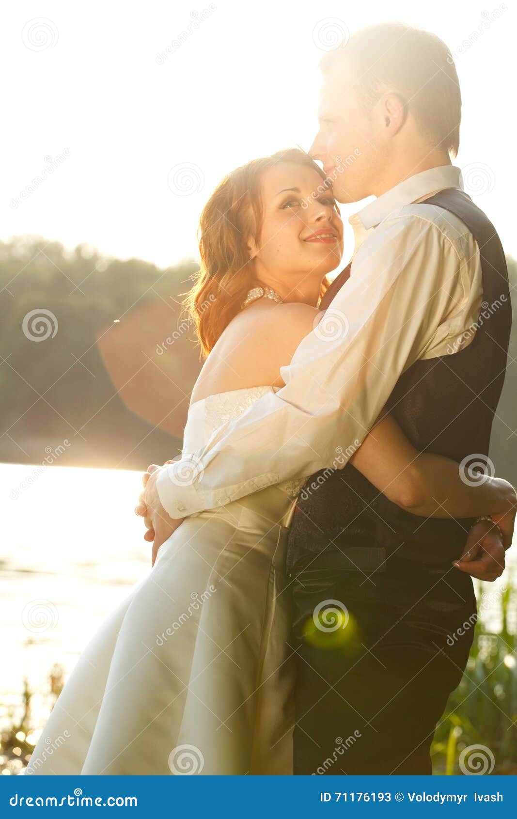 Illuminated Love Wedding Couple Hugs Behind A Lake Stock Image
