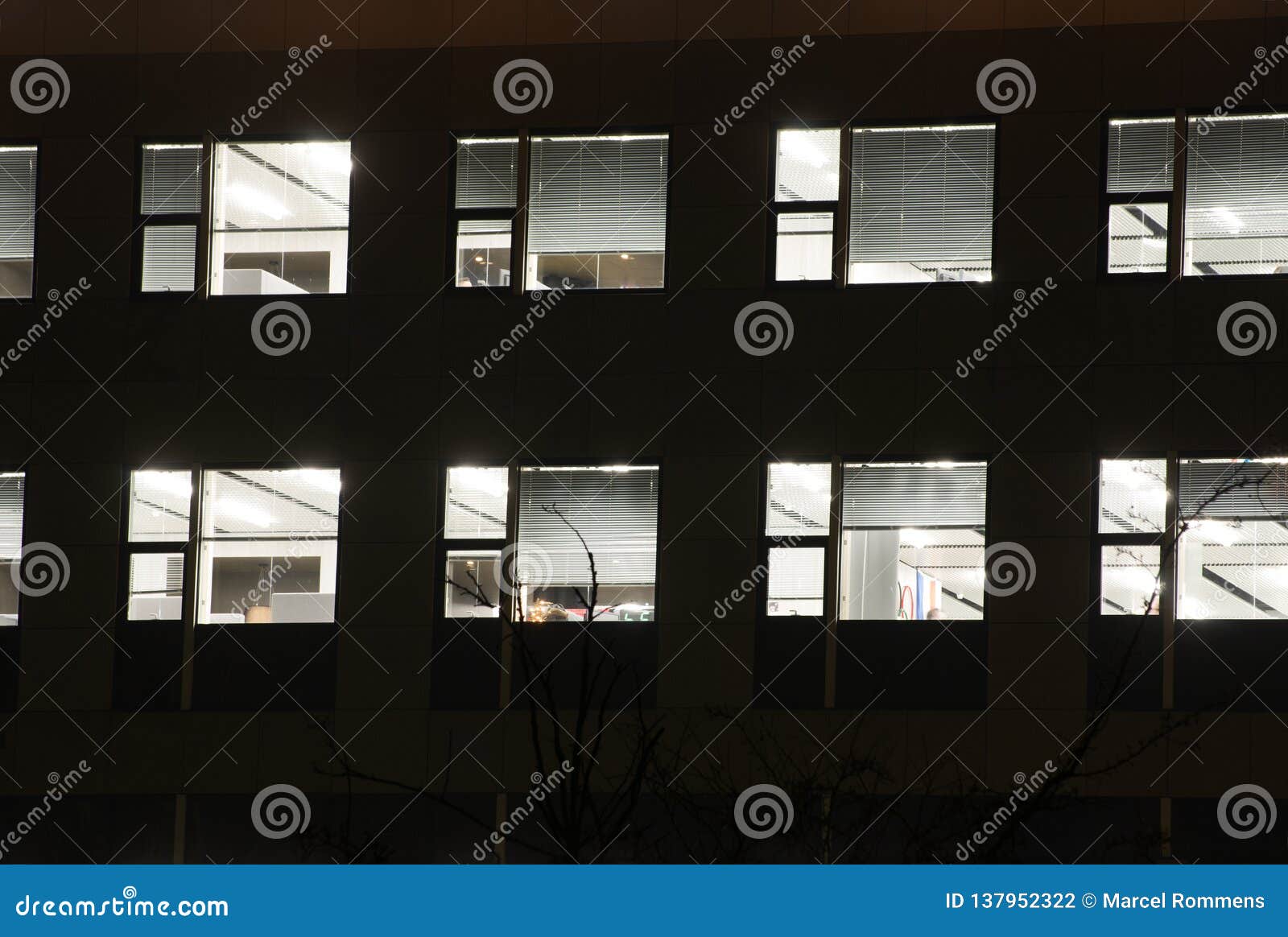 Illuminated office windows stock photo. Image of illuminated - 137952322