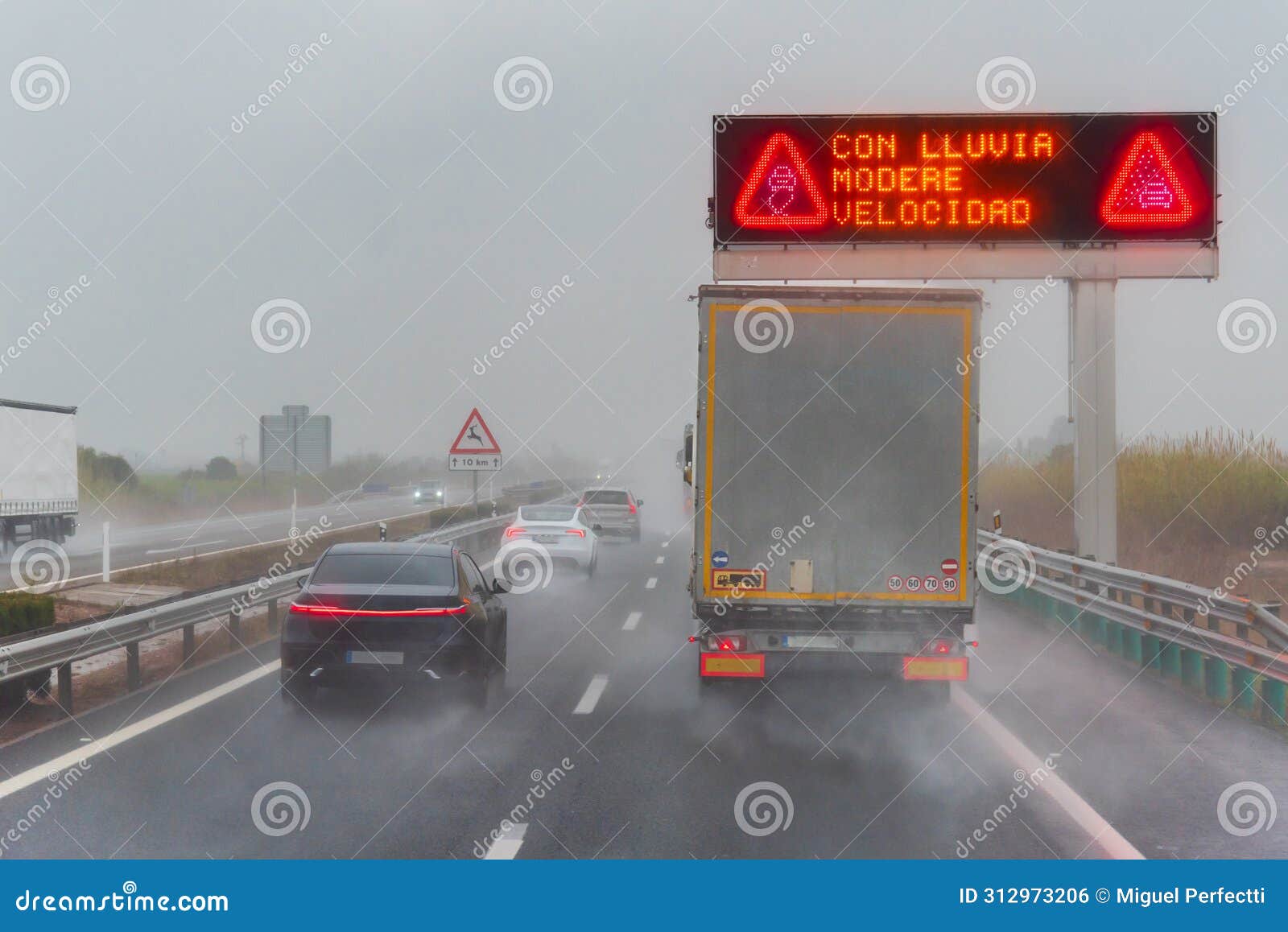 Illuminated Panel on a Highway with the Legend in Rain, Moderate Speed ...