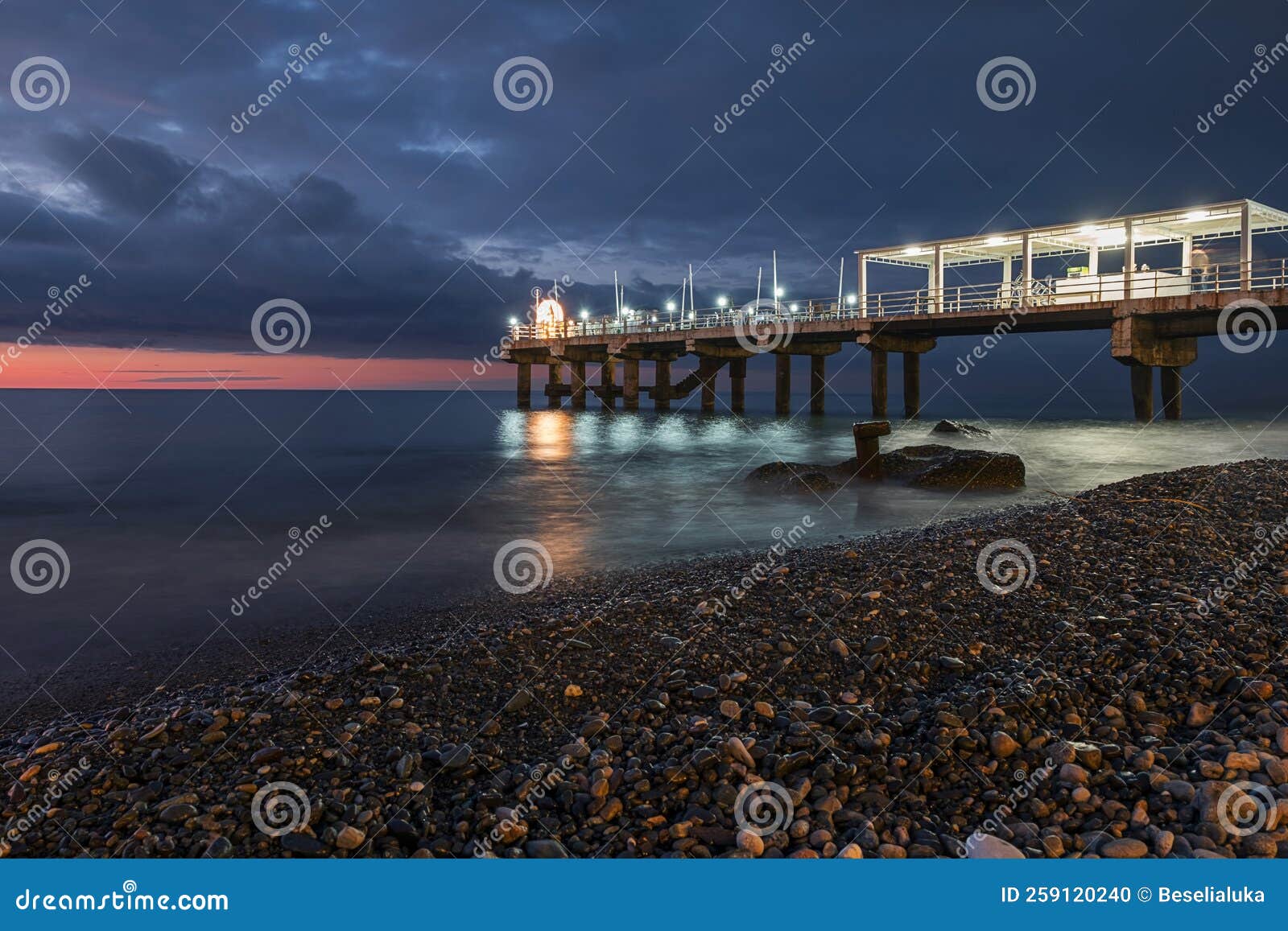 Illuminated Pier at Night on Beach Stock Photo - Image of quiet ...