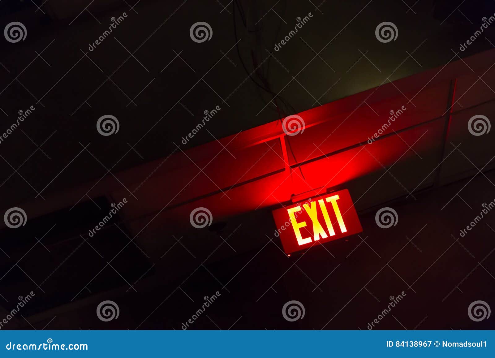 Illuminated red exit sign stock image. Image of illuminated - 84138967