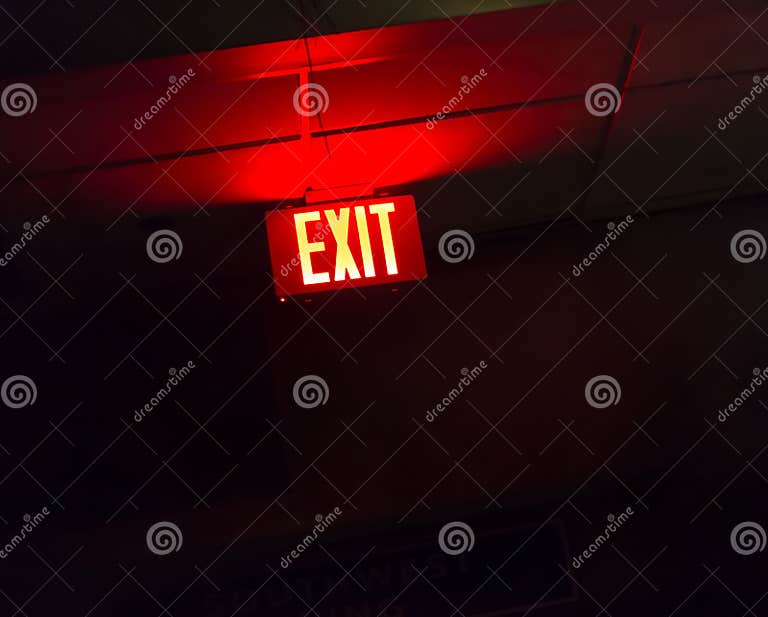 Illuminated red exit sign stock image. Image of text - 84949633