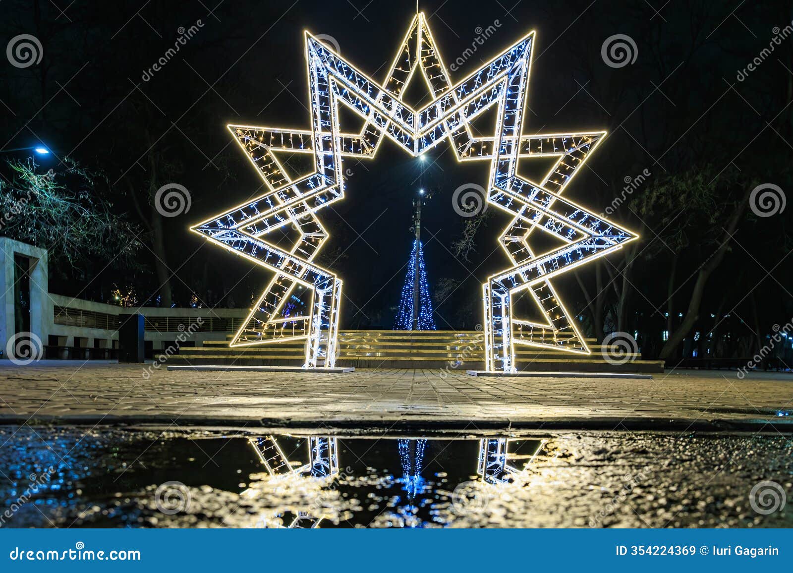 Illuminated Star Structure and Reflection at Night in Park Stock Image ...