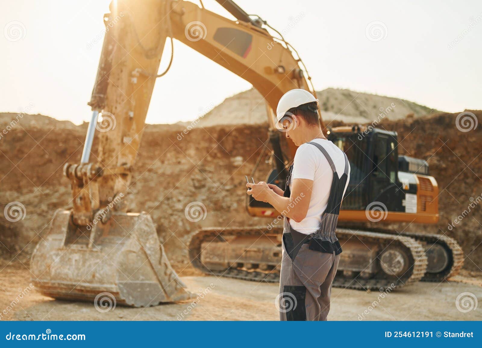 Illuminated by Sunlight. Worker in Professional Uniform is on the ...