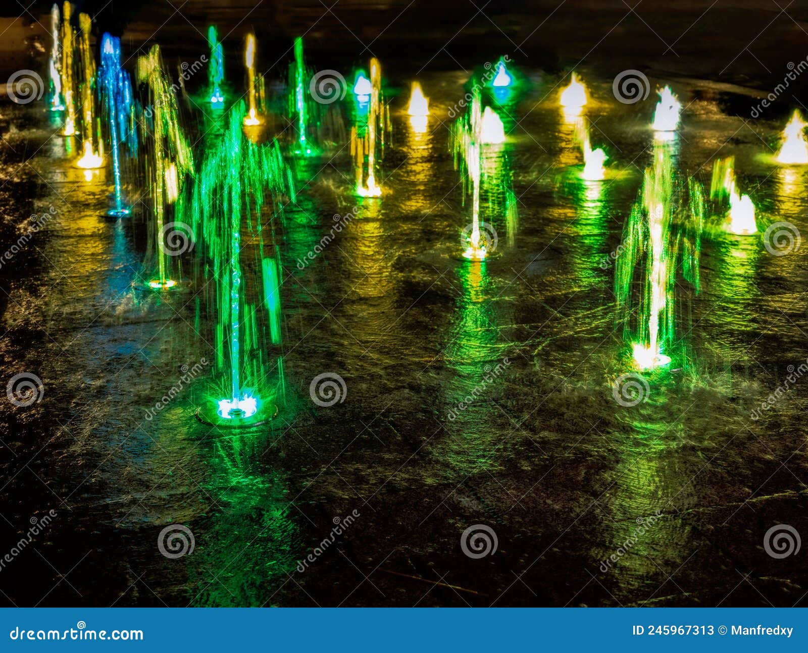Illuminated Waterspout Fountain at Night Stock Image - Image of blue ...