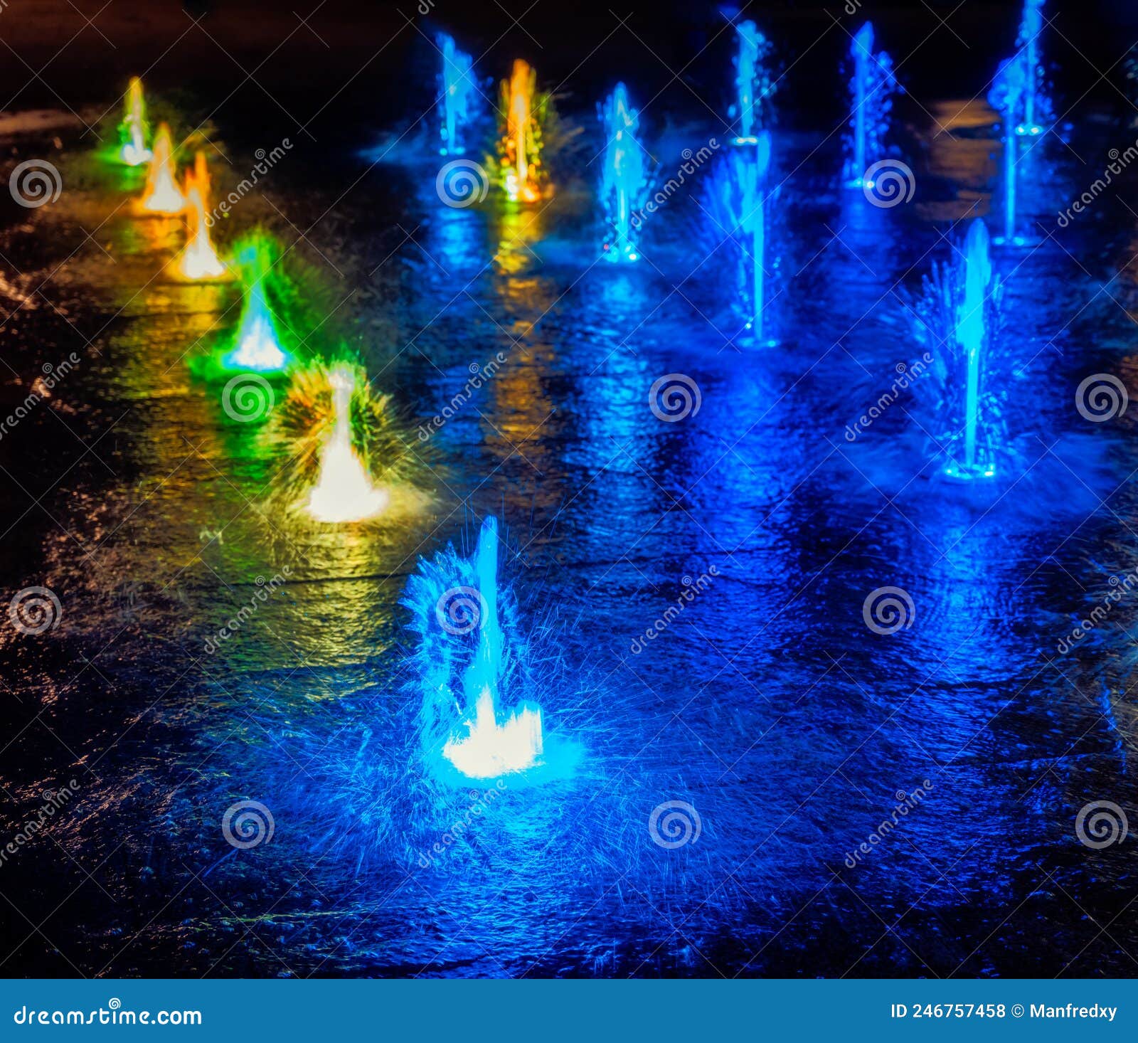 Illuminated Waterspout Fountain at Night Stock Photo - Image of lights ...