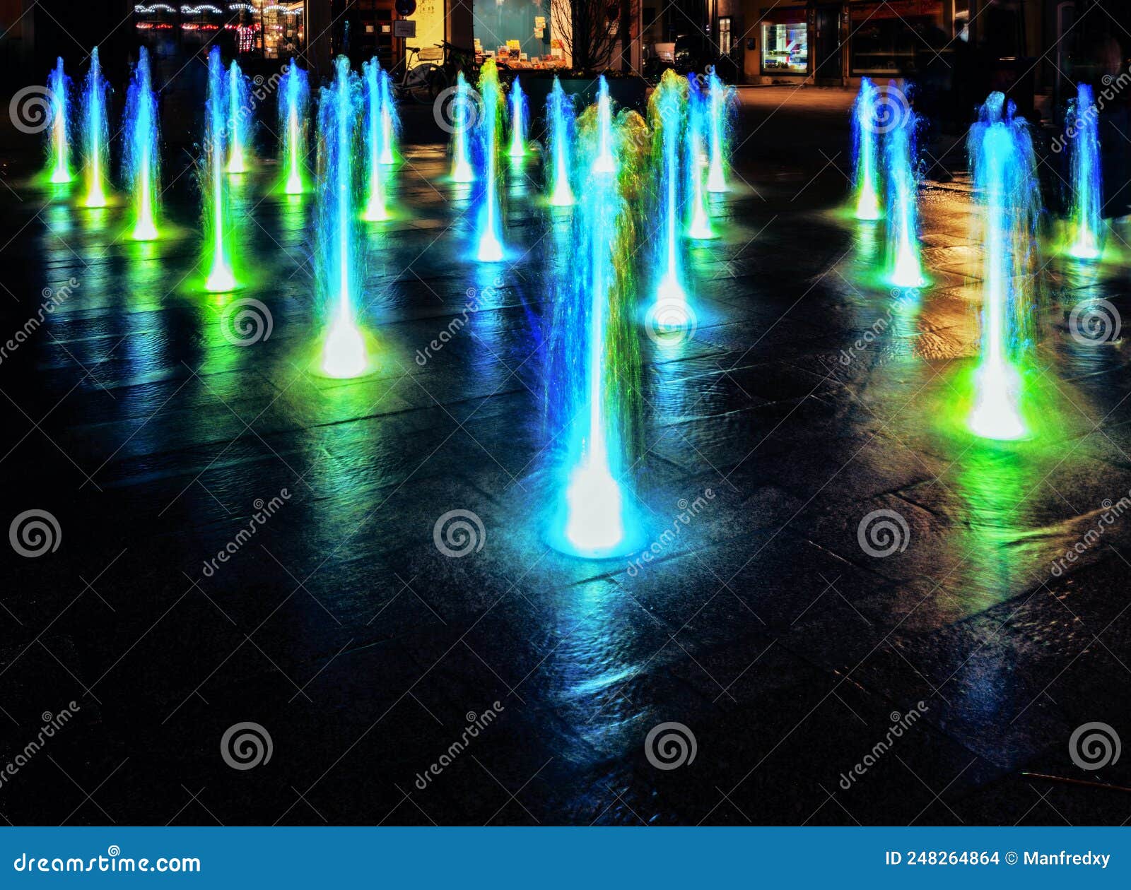 Illuminated Waterspout Fountain at Night Stock Photo - Image of ...