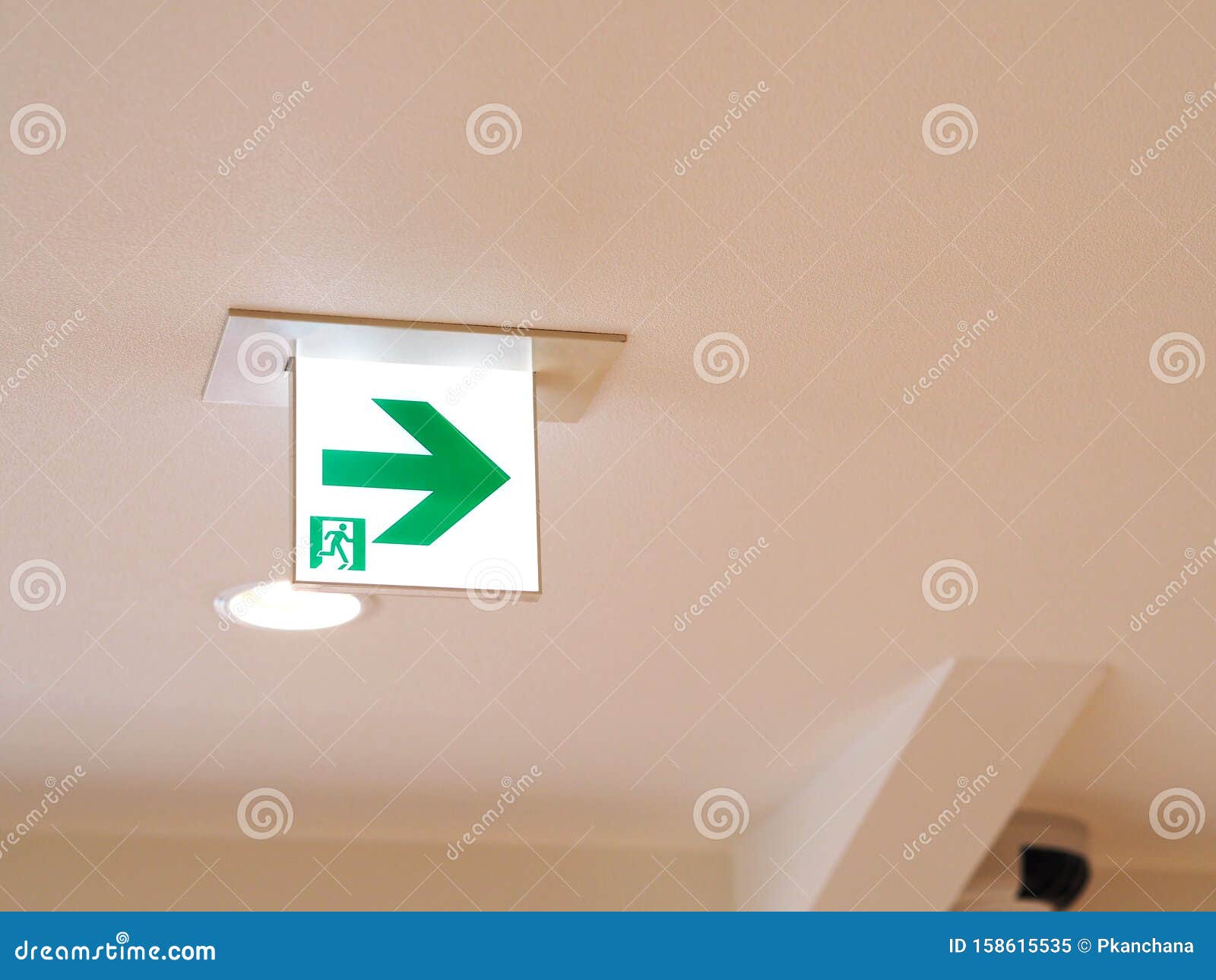 Illuminated Exit Sign Hanging from the Ceiling Stock Image - Image of ...