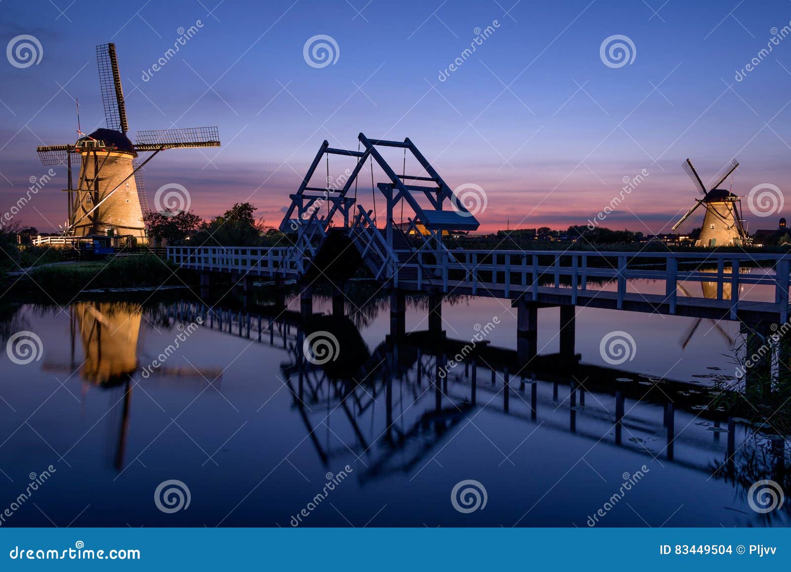 Illuminated Windmills, a Bridge and a Canal at Sunset Stock Photo ...