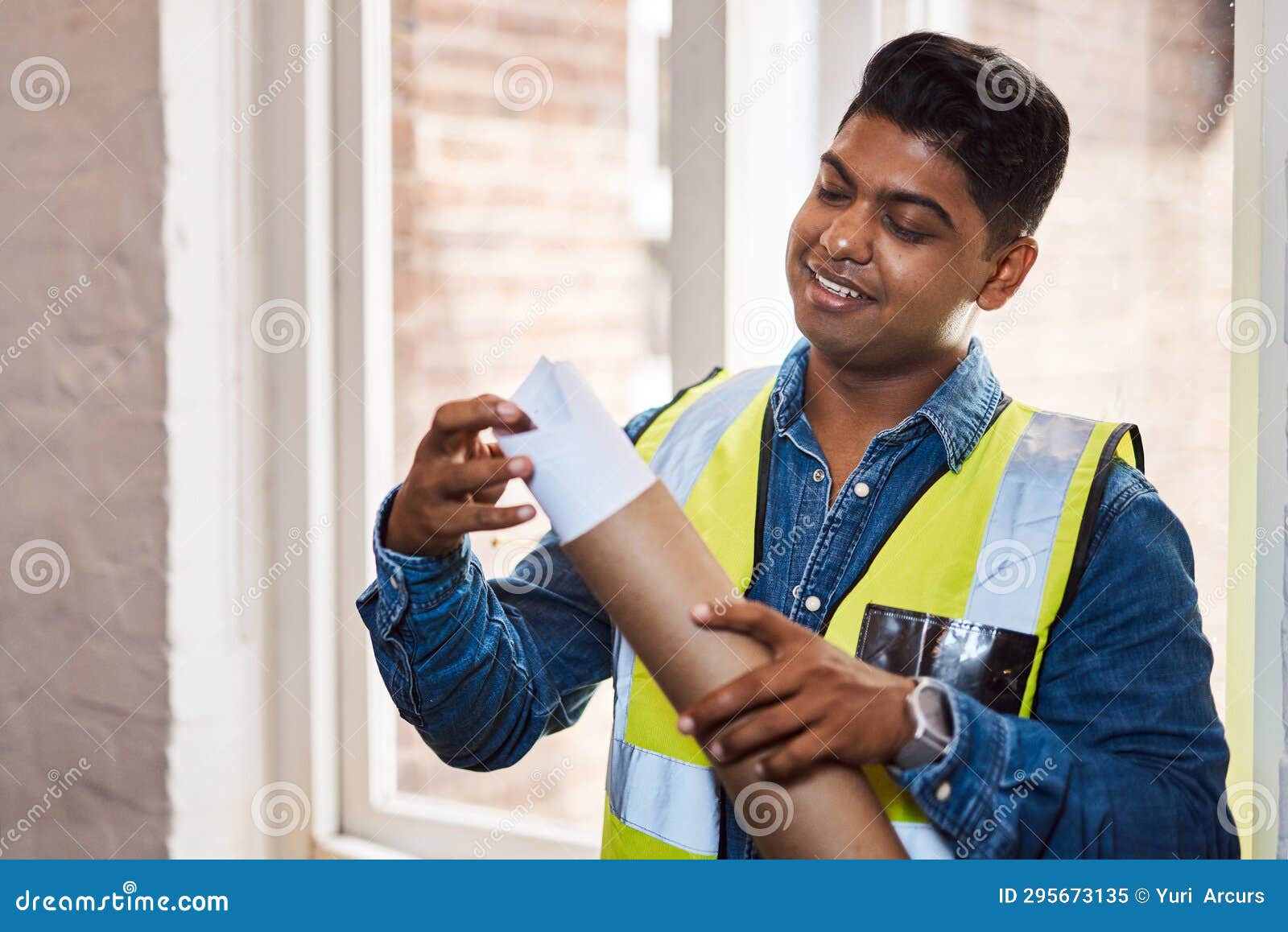 Im Excited about this Project. a Young Engineer Holding a Blueprint ...