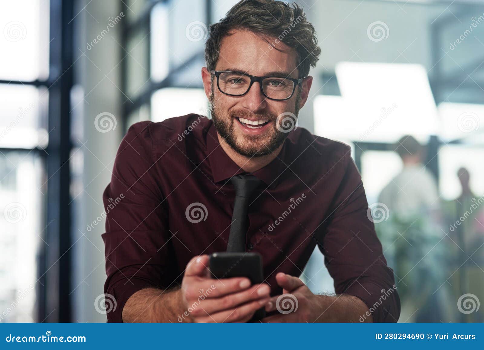 Im Ready for Your Call. a Young Businessman Using a Mobile Phone in a ...