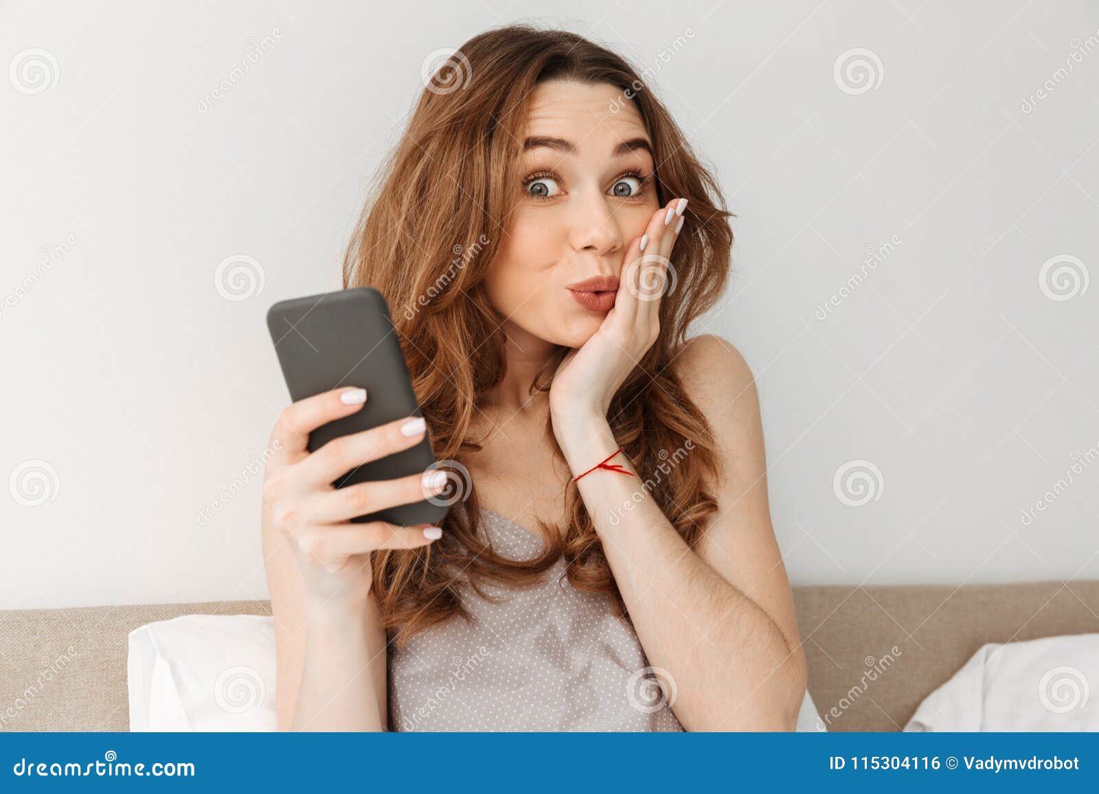 Image of Amusing Blushing Woman Finding Exciting Information in Stock ...