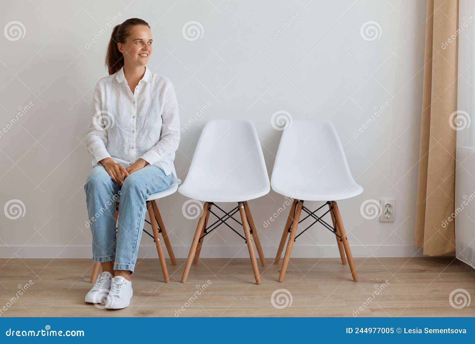Image Of Attractive Dark Haired Woman Wearing White Shirt And Jeans