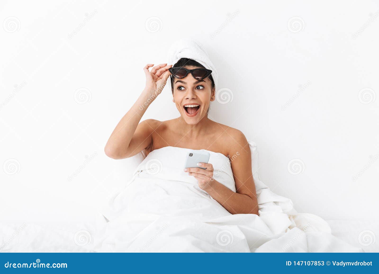 Beautiful Surprised Emotional Woman With Towel On Head Lies In Bed