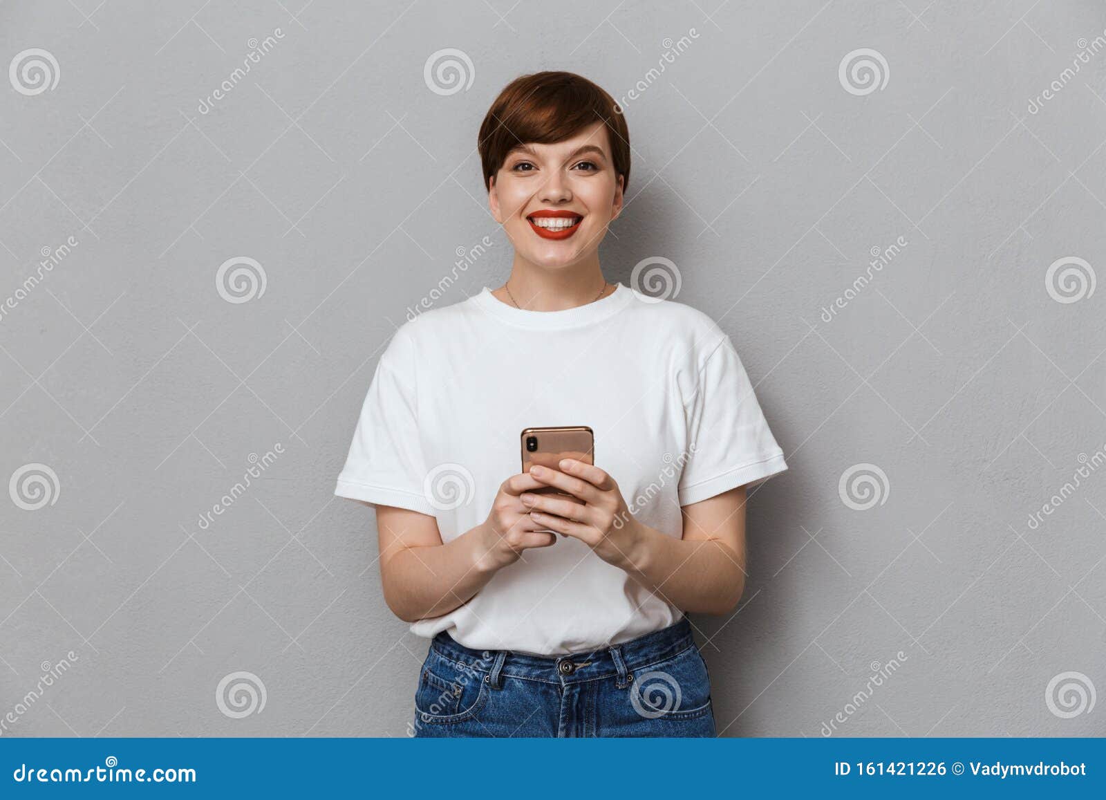 Image of Beautiful Young Woman Smiling and Holding Cellphone Stock ... Image of Beautiful Young Woman Smiling and Holding Cellphone Stock ...