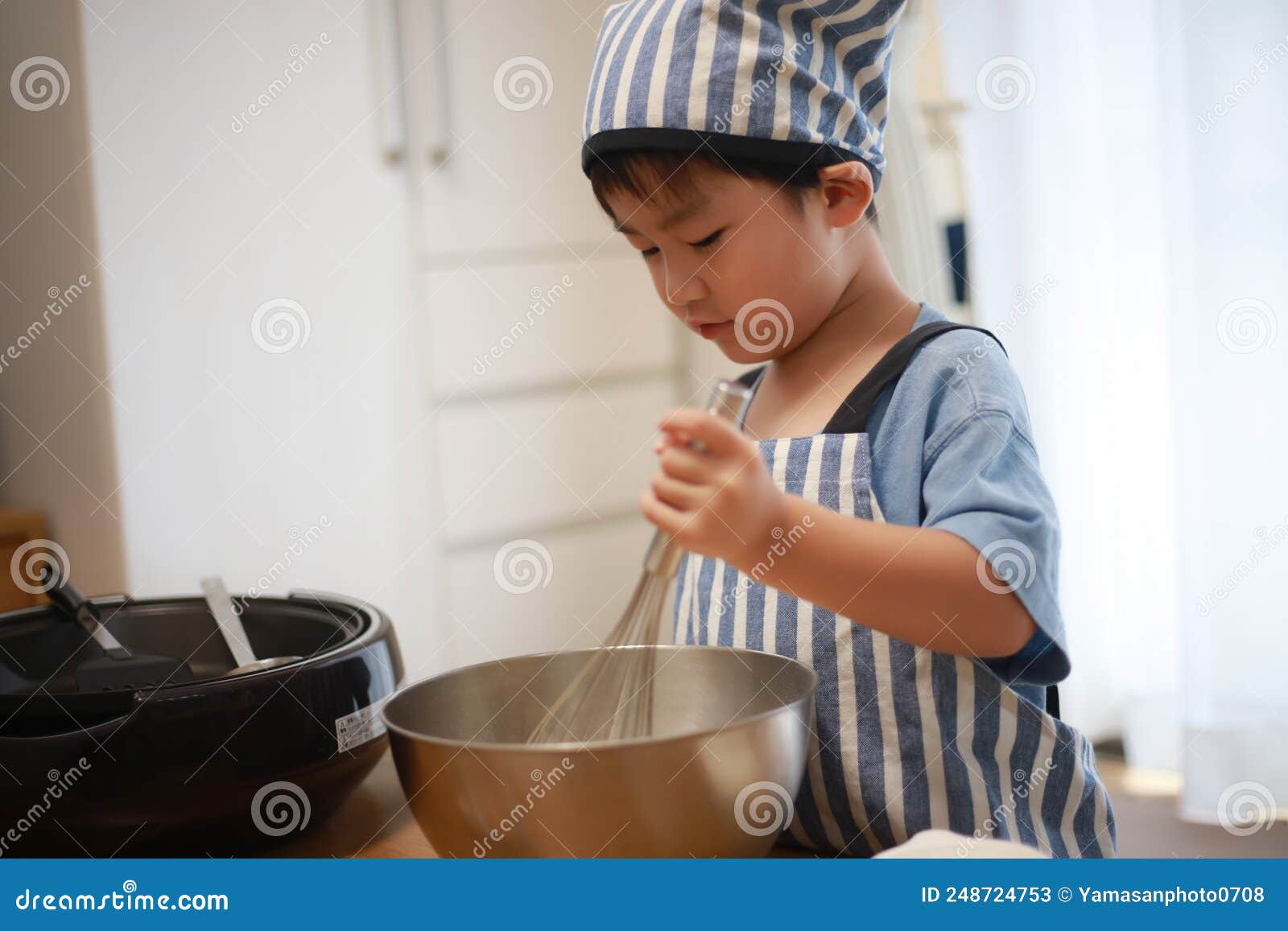 Boy making pancakes stock image. Image of cookware, food - 248724753