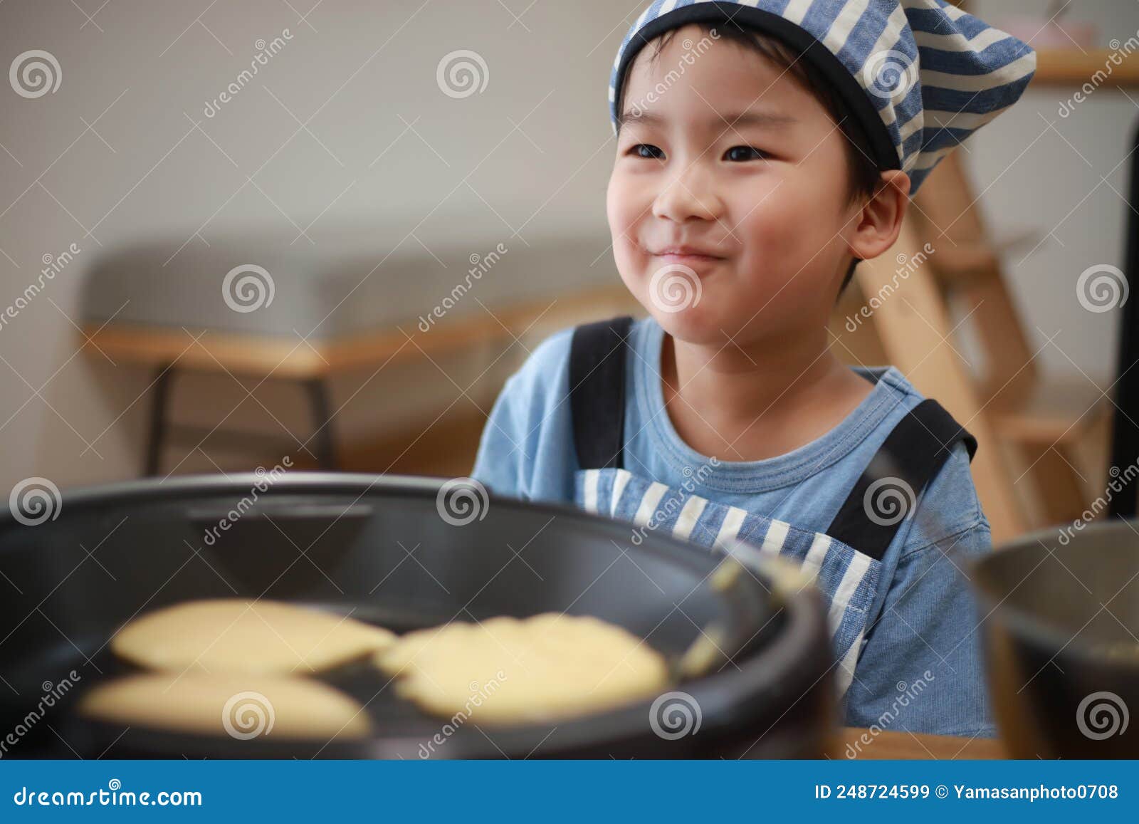 Boy making pancakes stock image. Image of smiling, bowl - 248724599