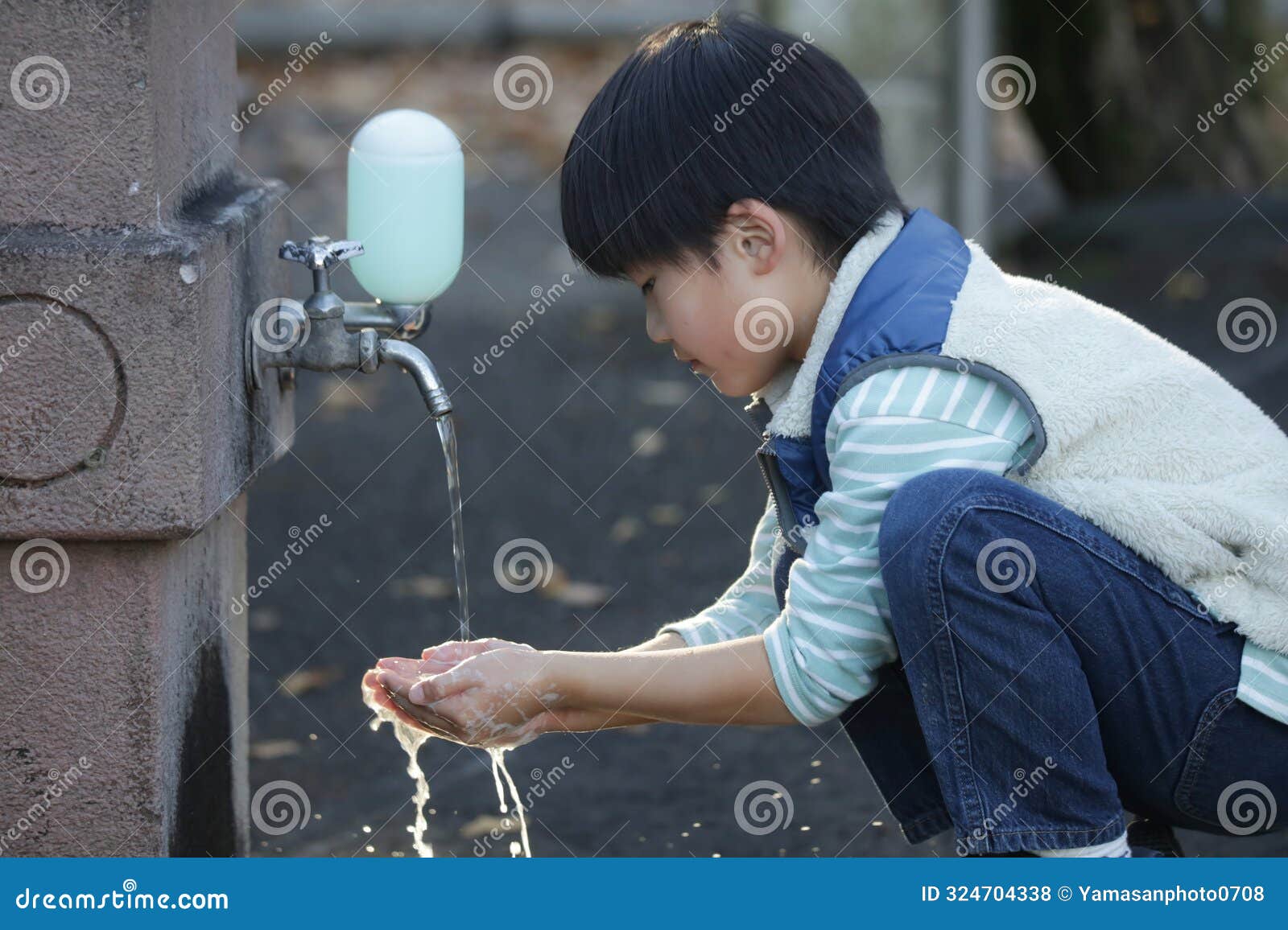 Boy washing his hands stock photo. Image of clean, wash - 324704338