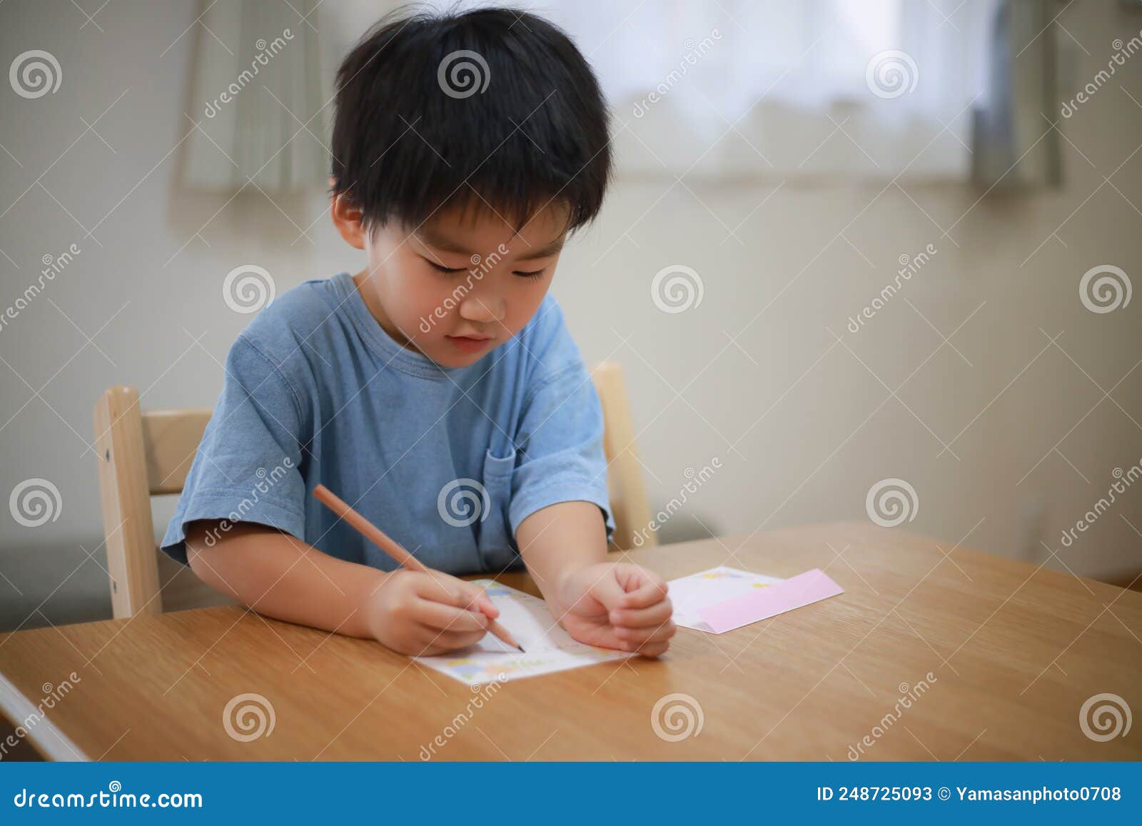 Boy writing a letter stock image. Image of indoors, pencils - 248725093