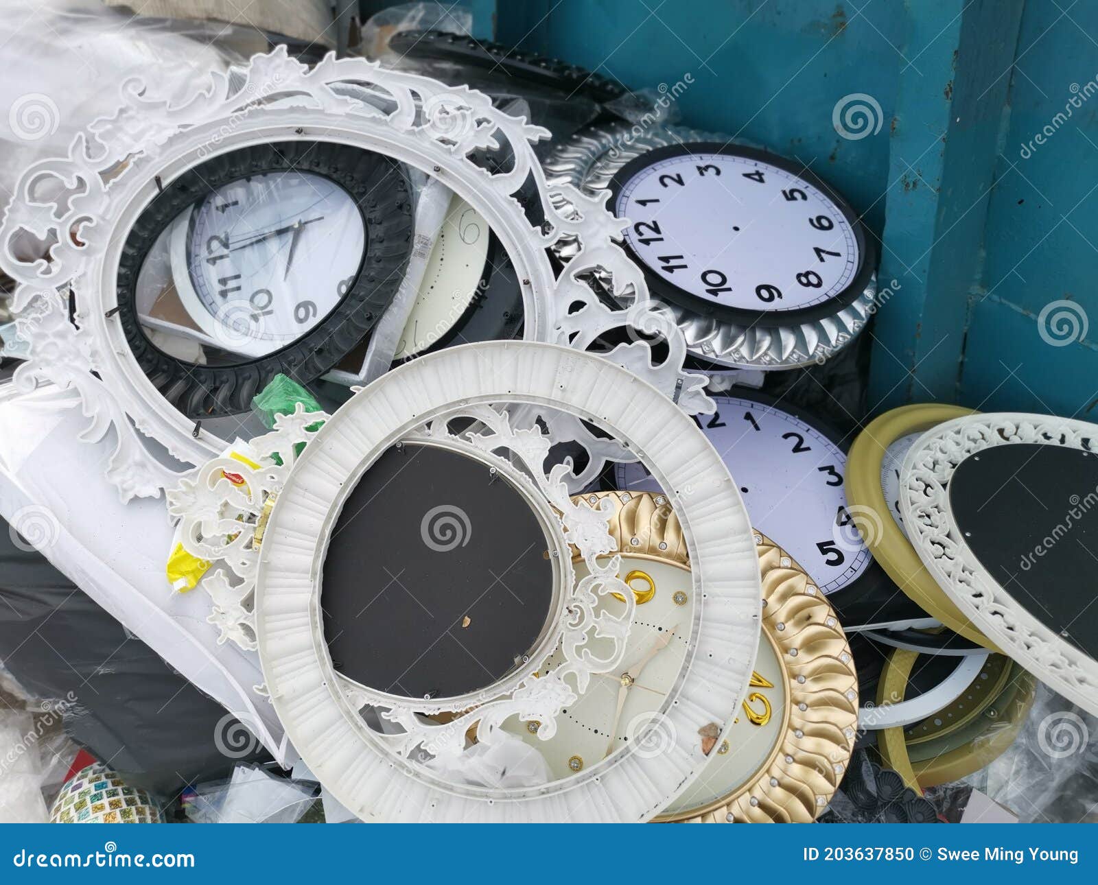 Broken Pieces of Wall Ceiling Clock at the Dumpster. Stock Photo ...