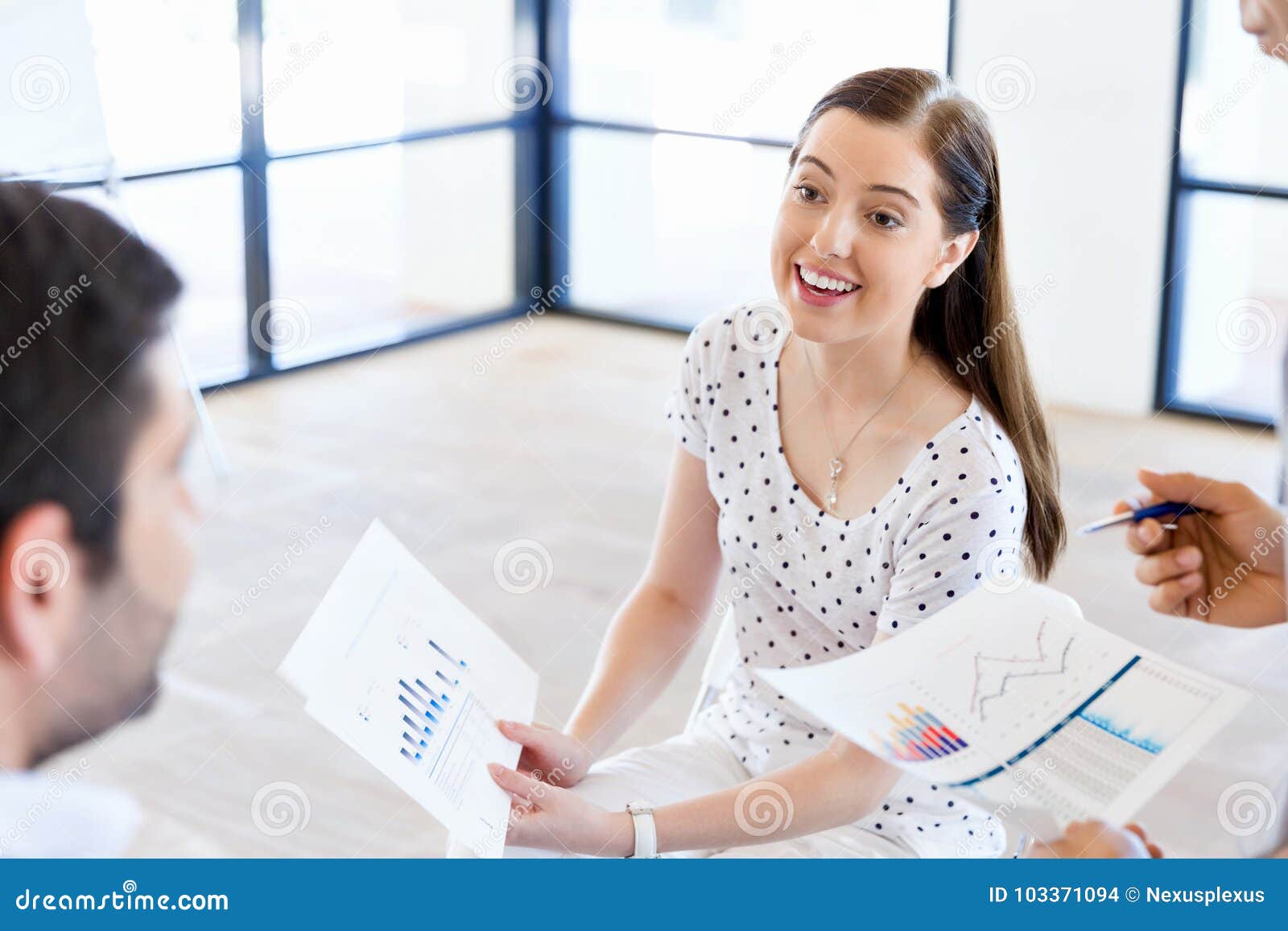 Image of Business Partners Discussing Documents and Ideas Stock Photo ...
