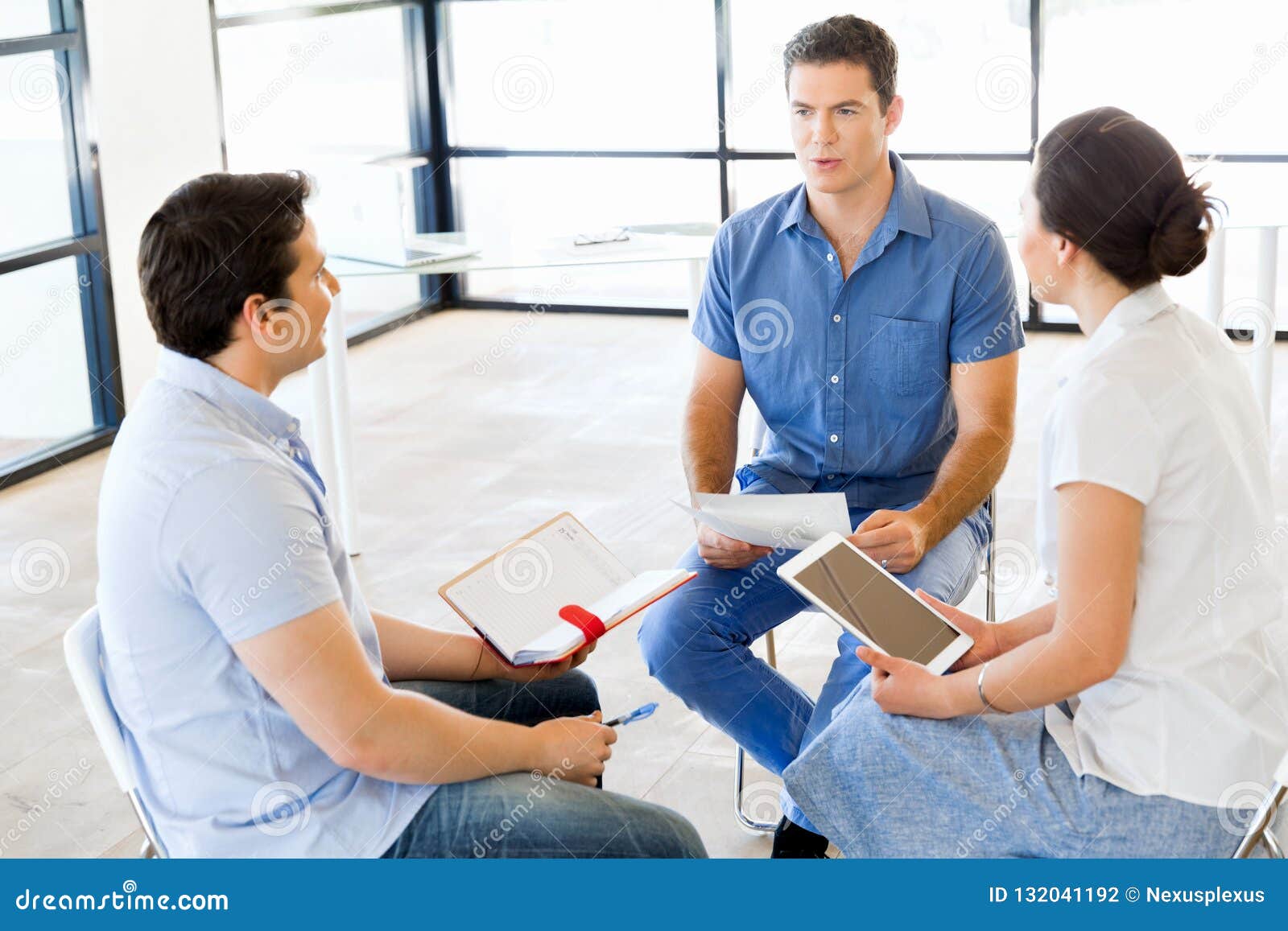 Image of Business Partners Discussing Documents and Ideas Stock Photo ...