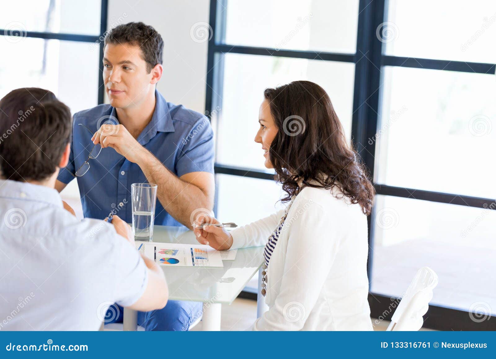 Image of Business Partners Discussing Documents and Ideas Stock Image ...