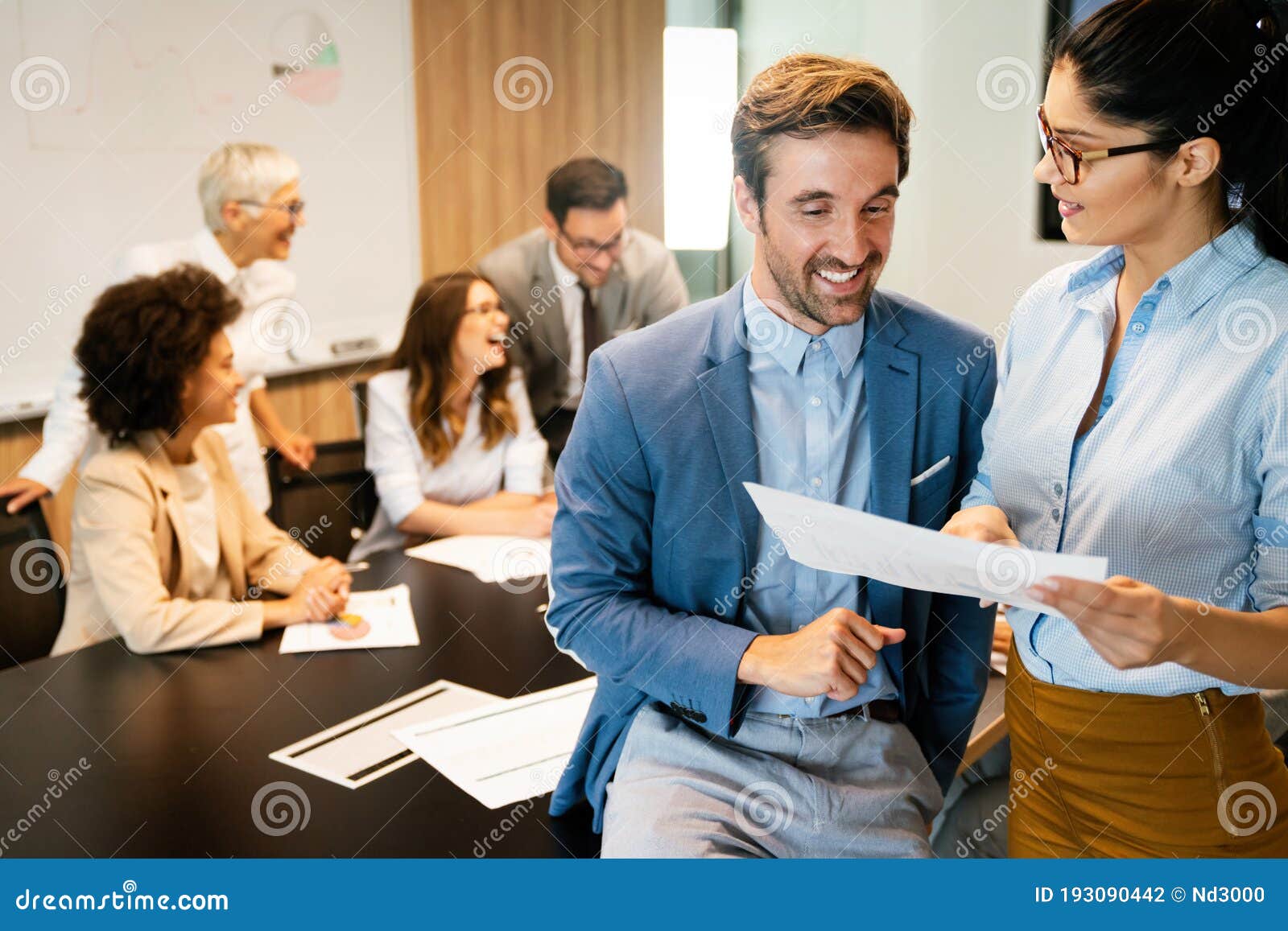 Image of Business Partners Discussing Documents and Ideas Stock Photo ...