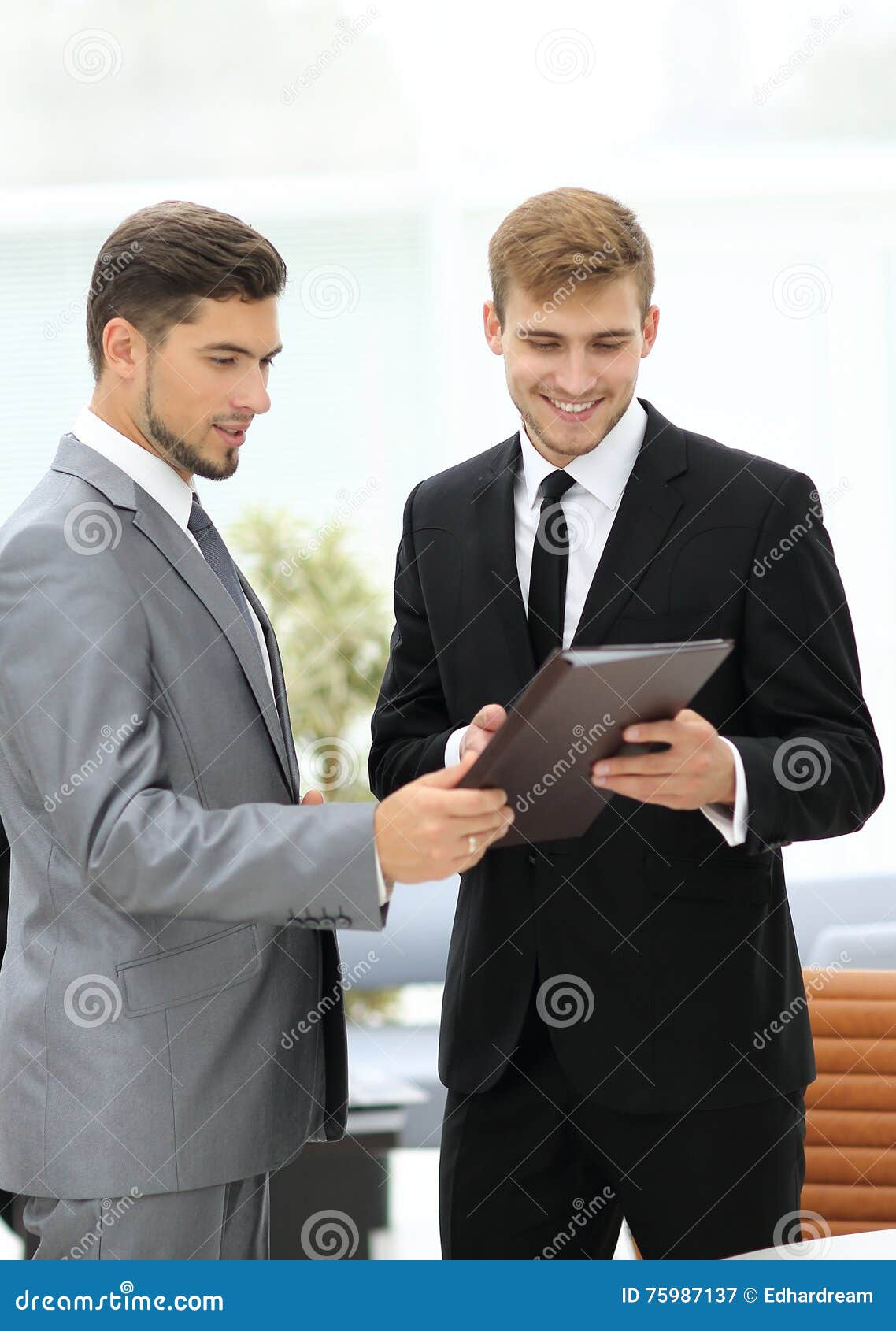 Image of Business Partners Discussing Documents and Ideas at Mee Stock ...