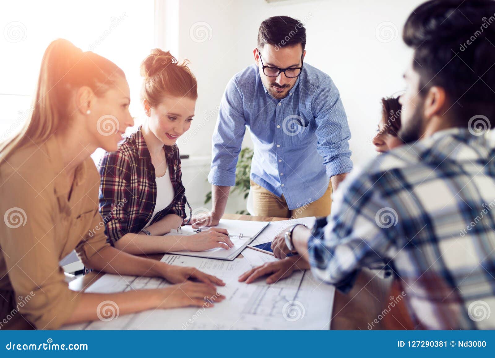 Image of Business Partners Discussing Documents and Ideas Stock Image ...