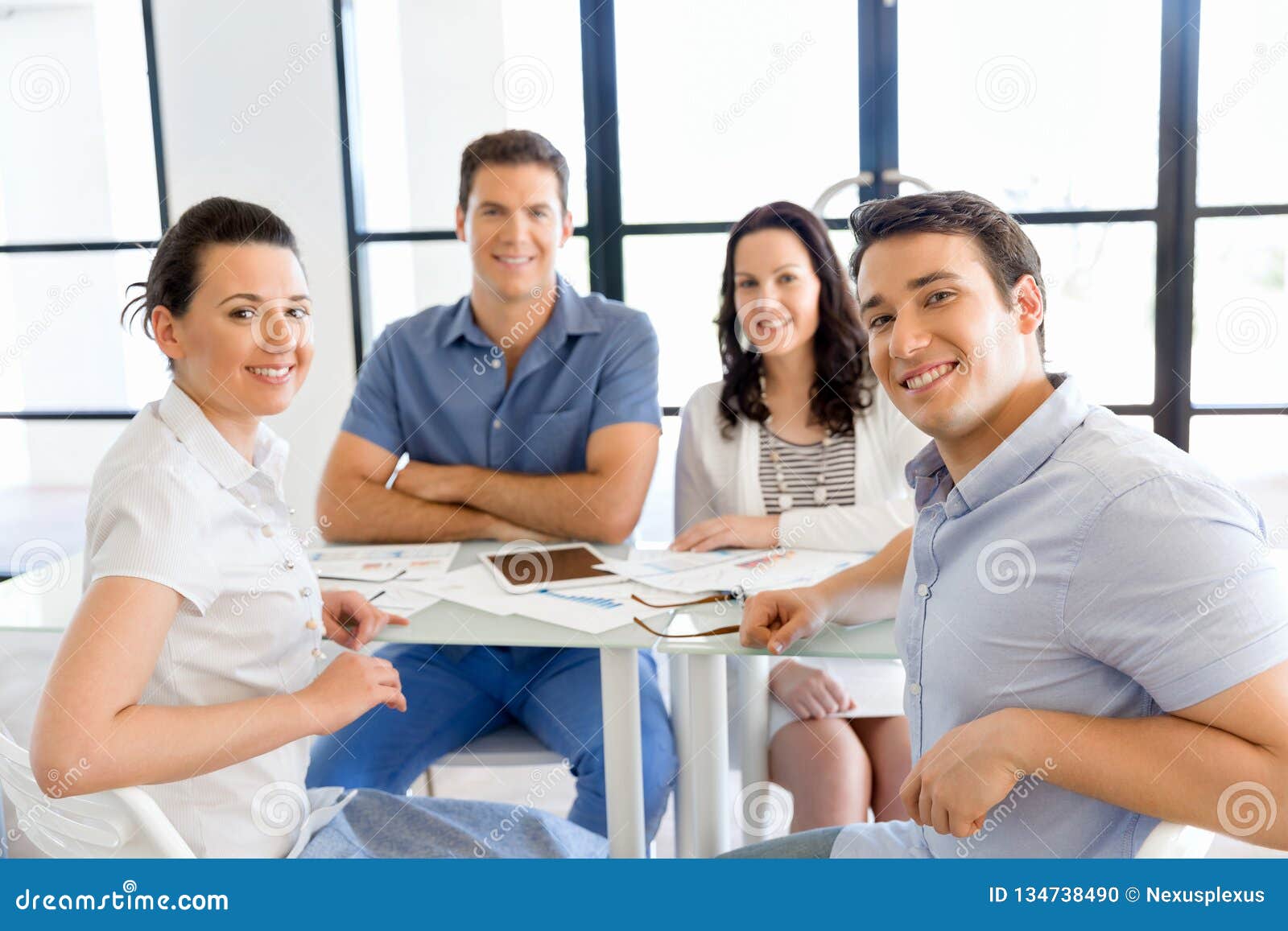 Image of Business Partners Discussing Documents and Ideas Stock Photo ...