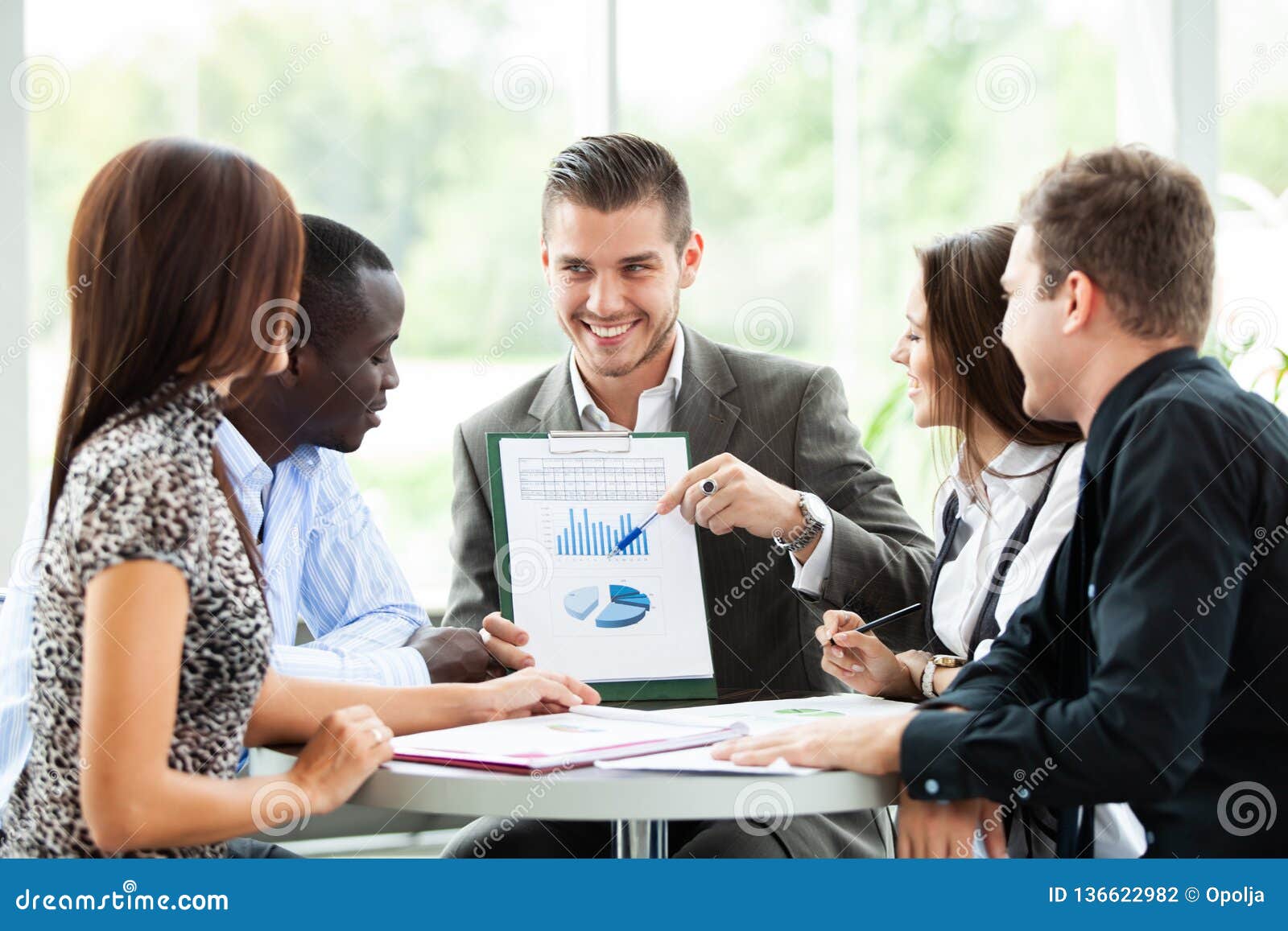 Image of Business Partners Discussing Documents and Ideas at Meeting ...