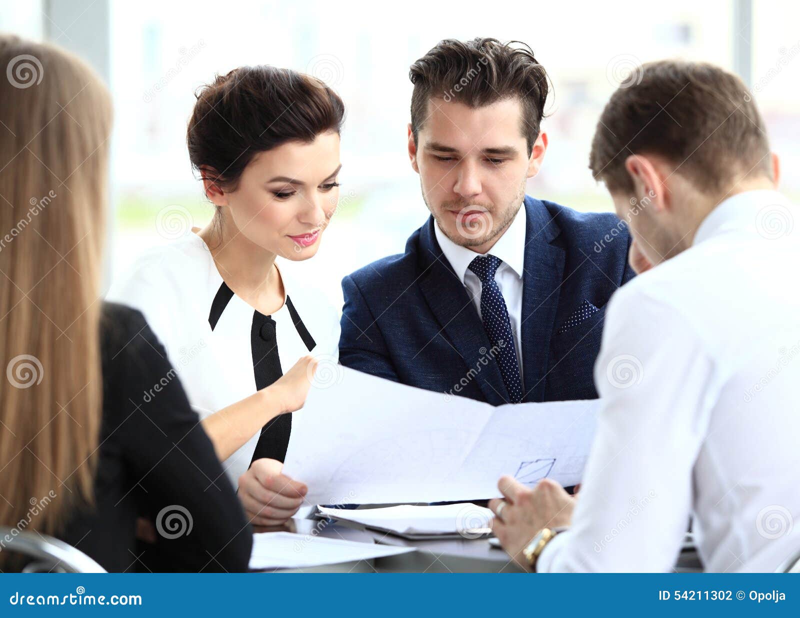 Image of Business Partners Discussing Documents and Ideas Stock Photo ...