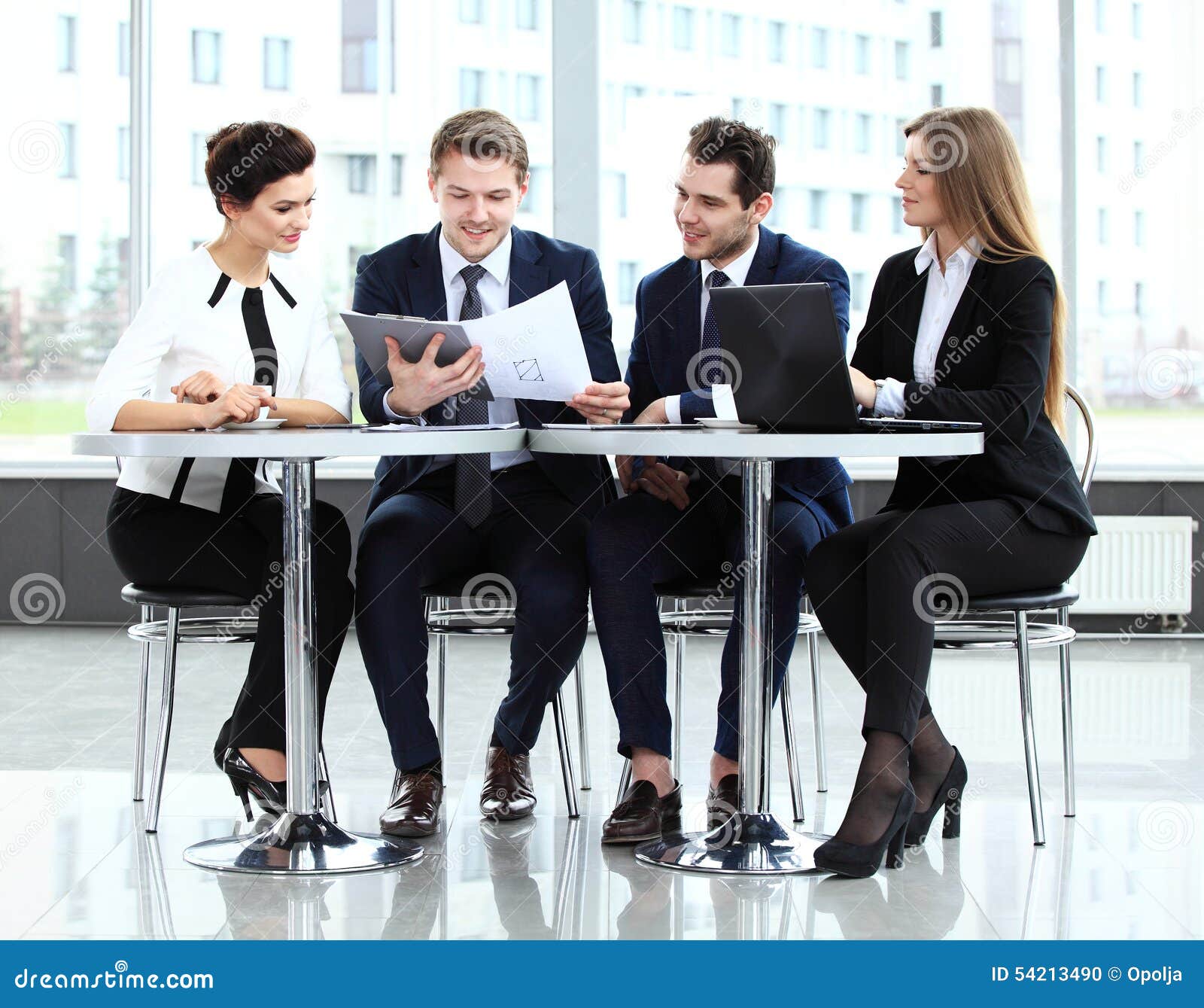Image of Business Partners Discussing Documents and Ideas Stock Photo ...