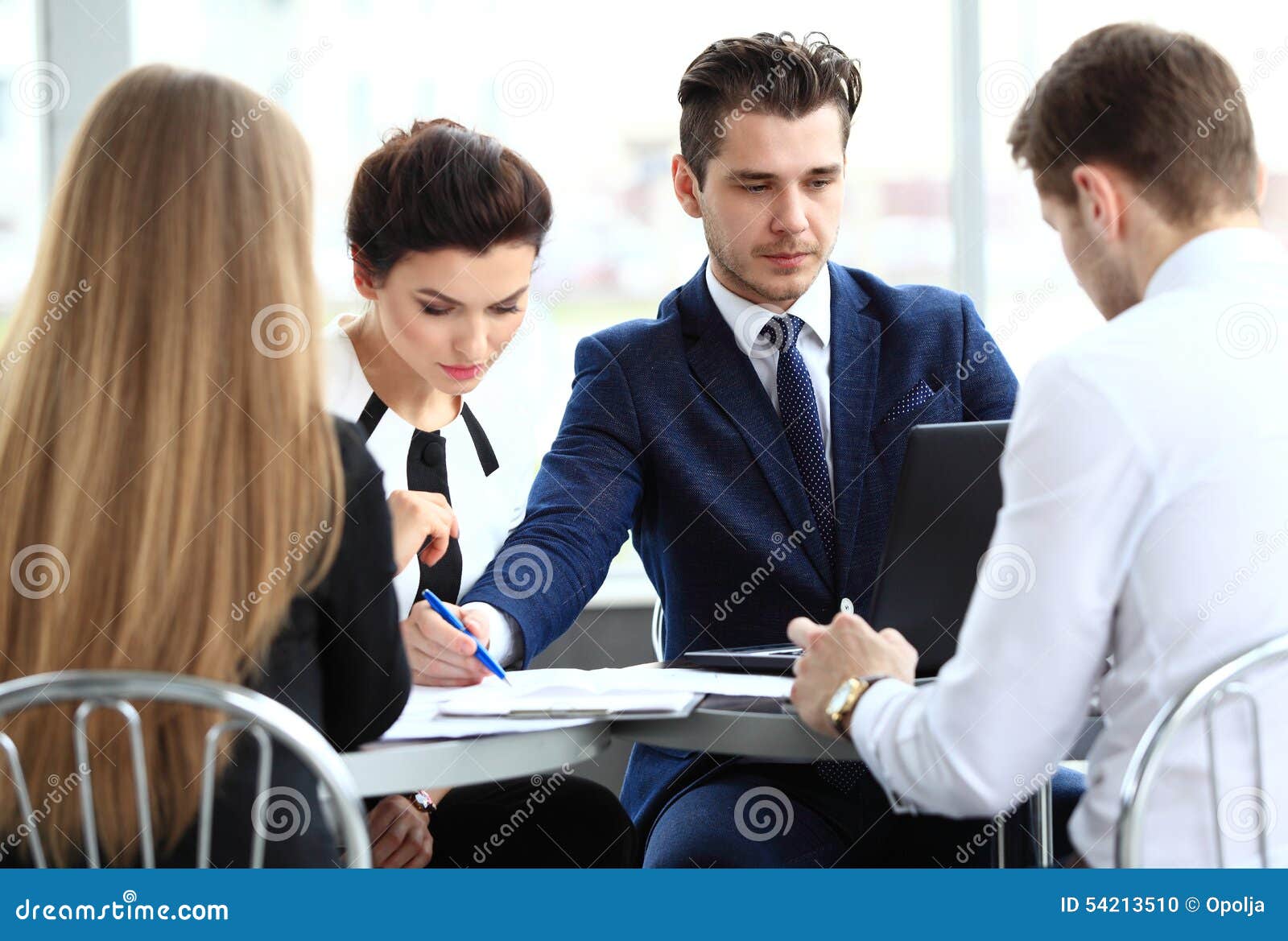 Image of Business Partners Discussing Documents and Ideas Stock Photo ...