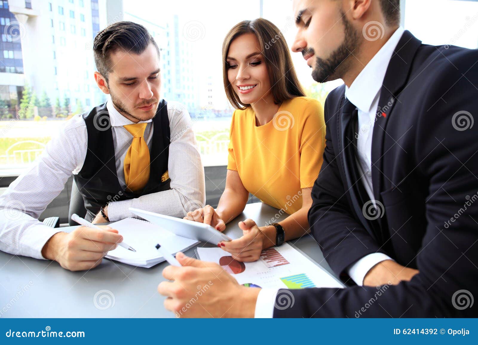 Image of Business Partners Discussing Documents and Ideas Stock Photo ...