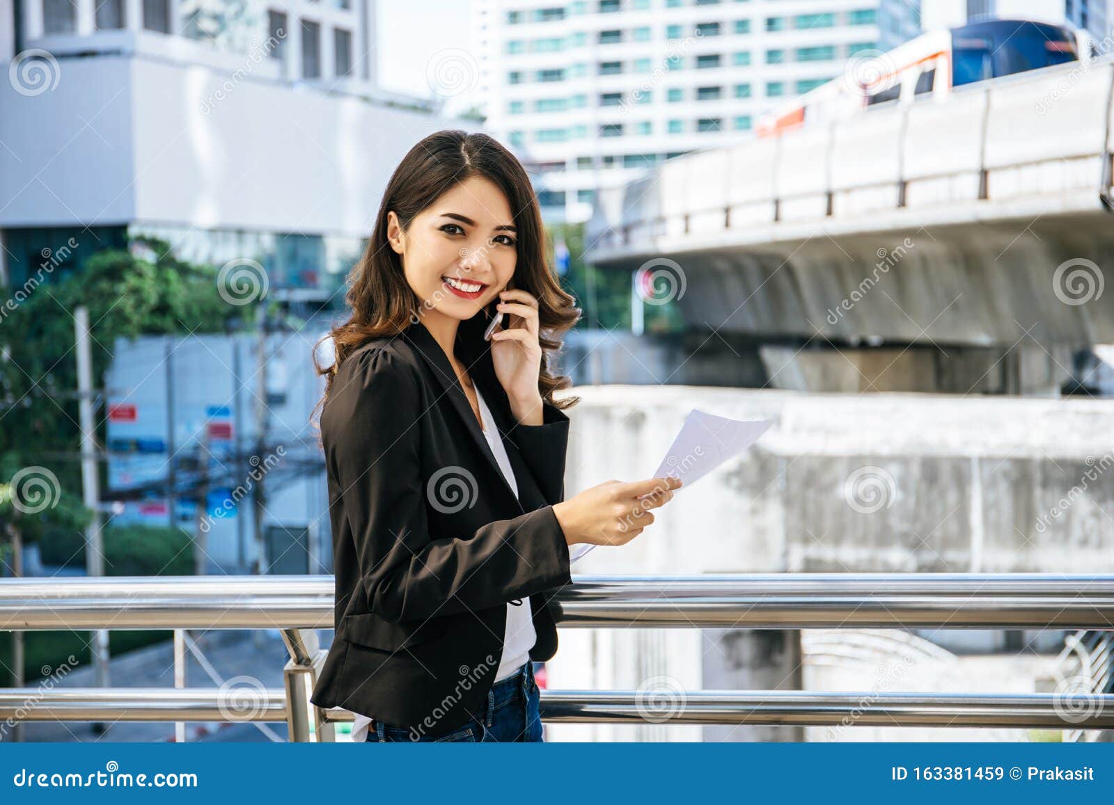 Image of Busy Female Calling on the Phone and Reading Document while ...