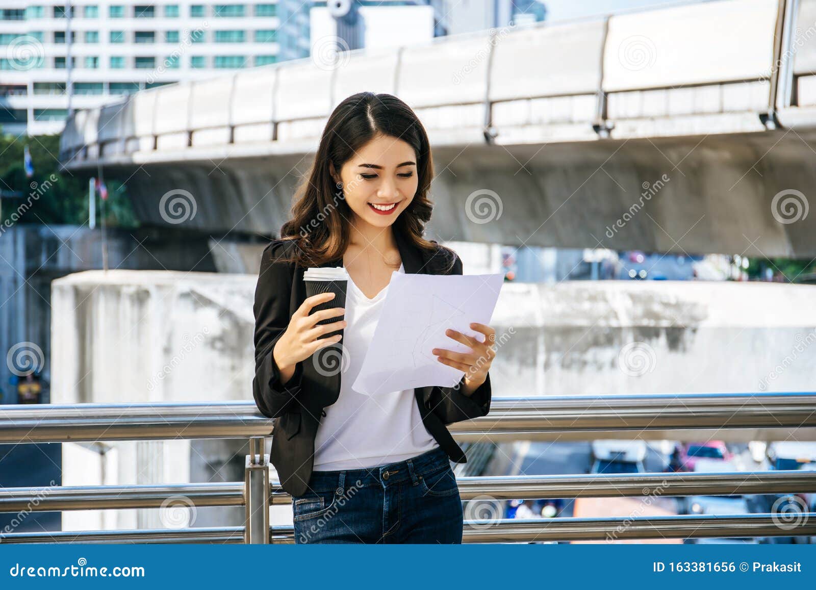 Image of Busy Female Calling on the Phone and Reading Document while ...